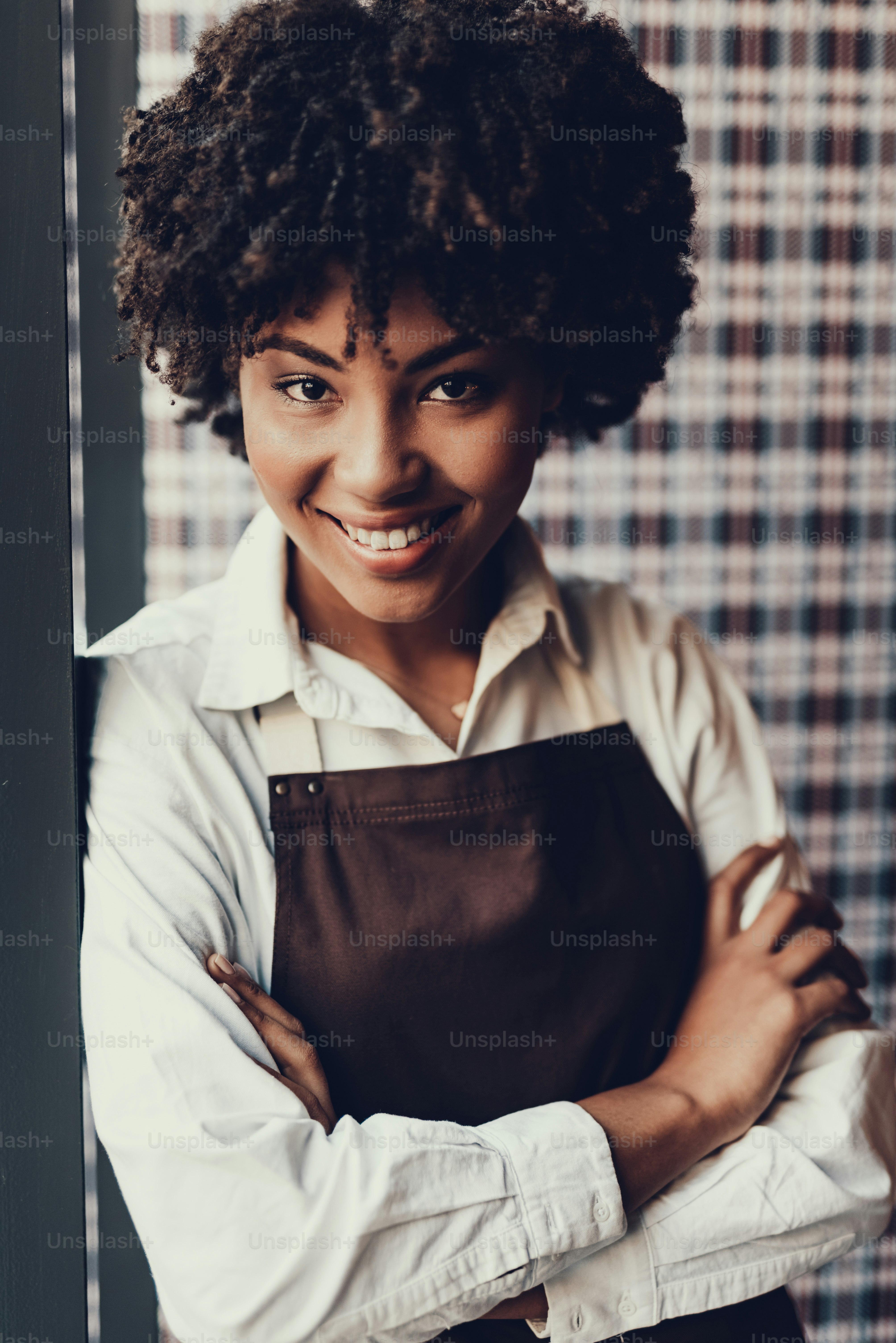 Vertical photo of attractive waitress looking at camera and folding ...