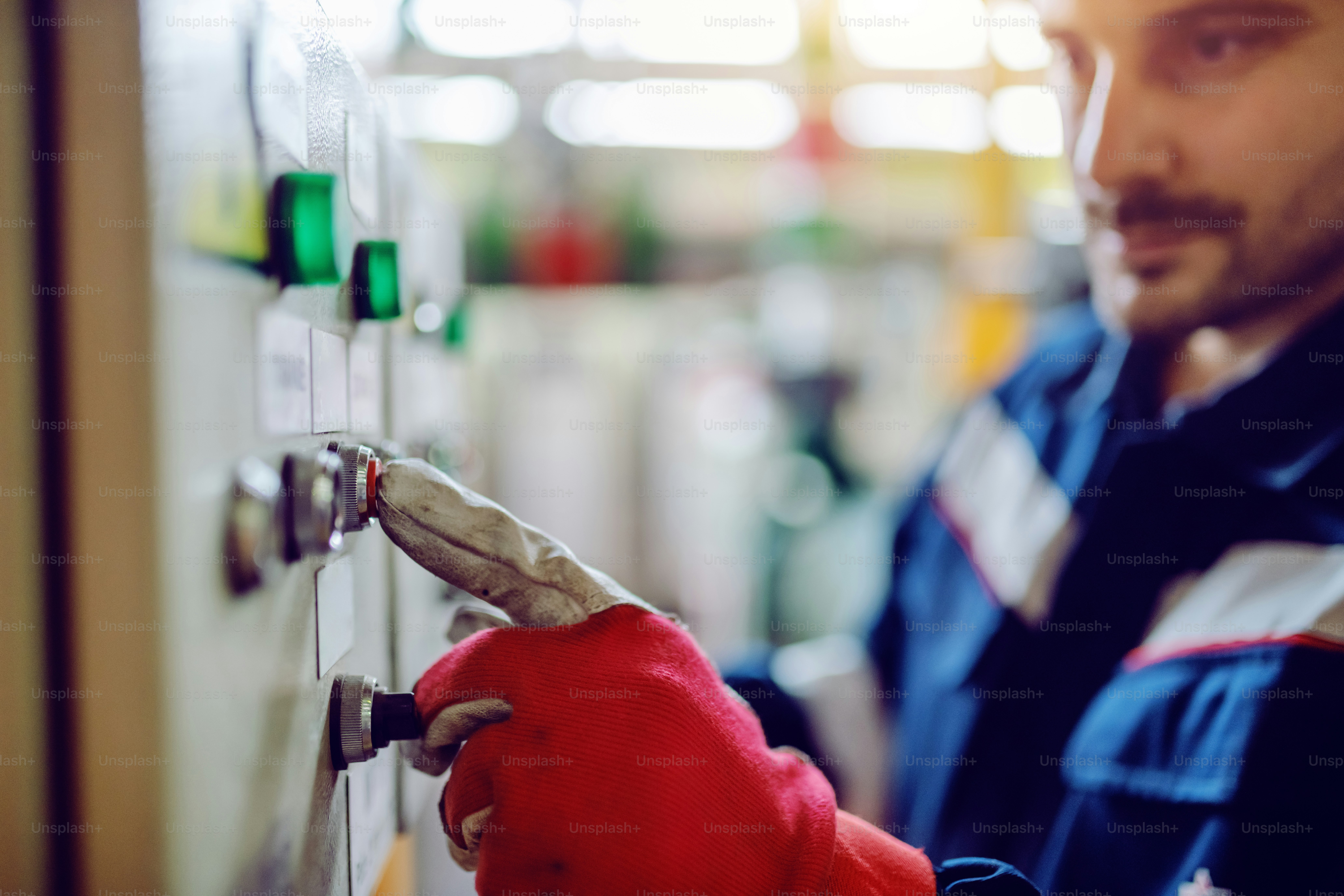Close up of energy plant worker pressing button on dashboard. photo ...