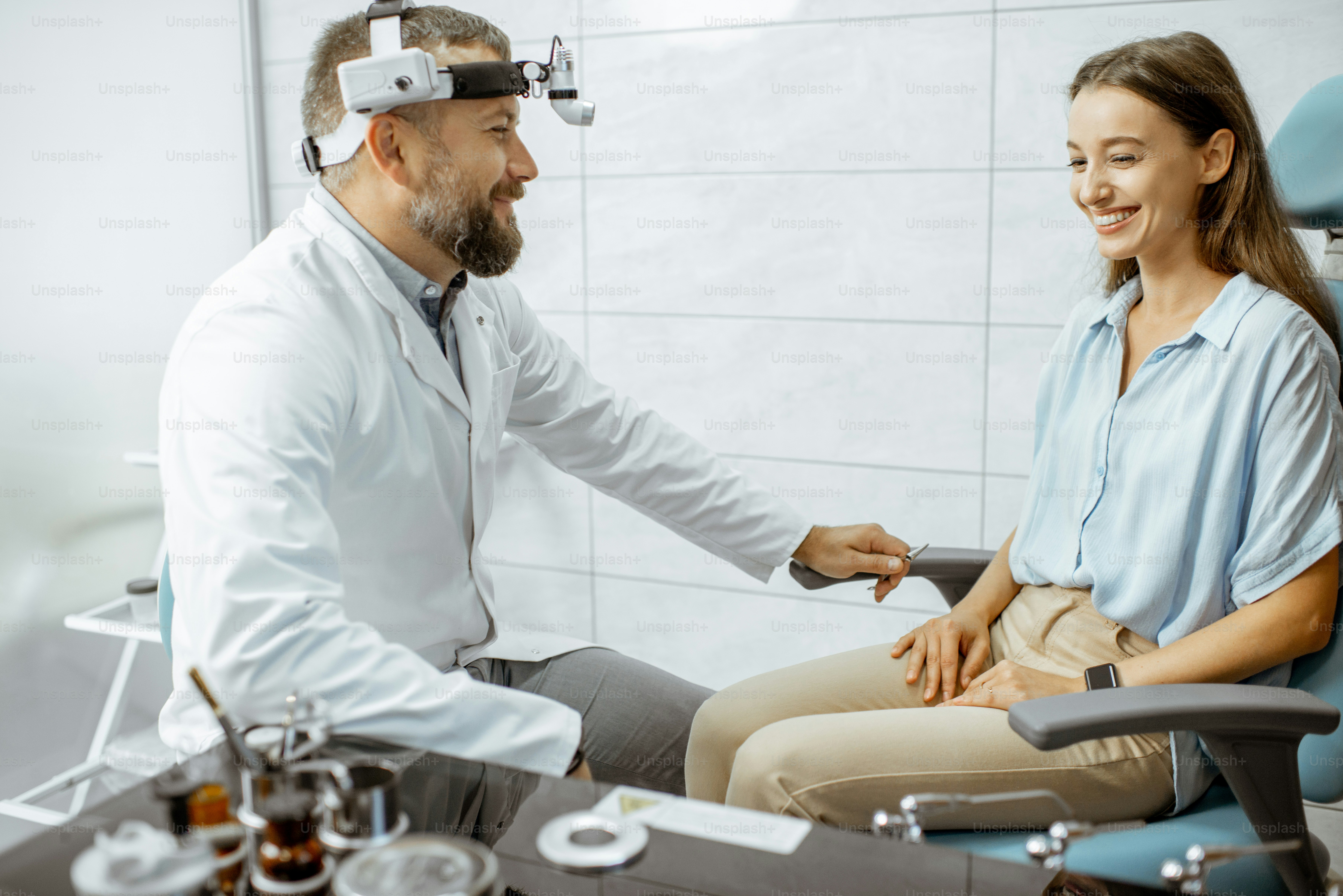 Senior otolaryngologist during a medical consultation with a young ...