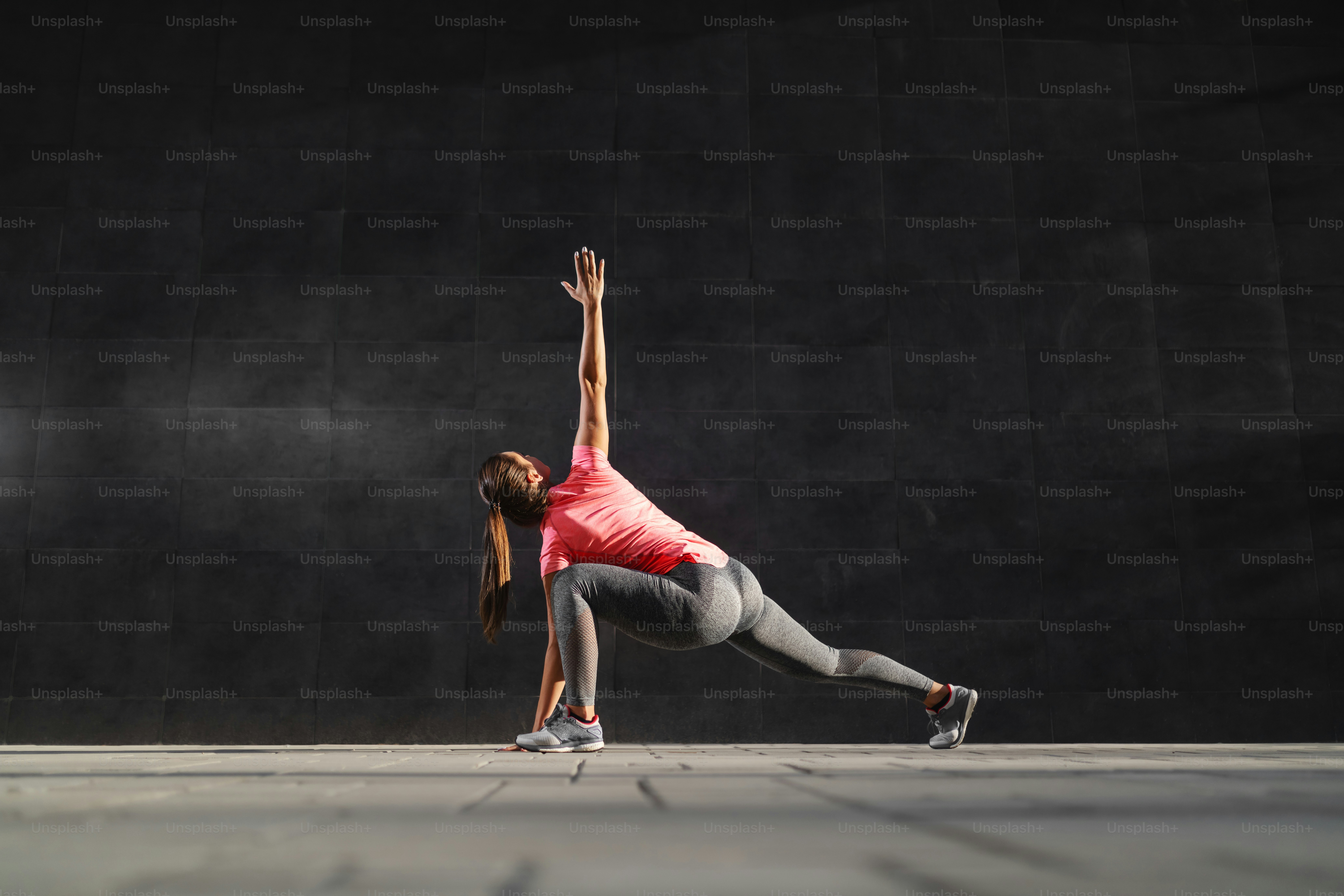 Side view of attractive fit caucasian brunette in sportswear and with ...