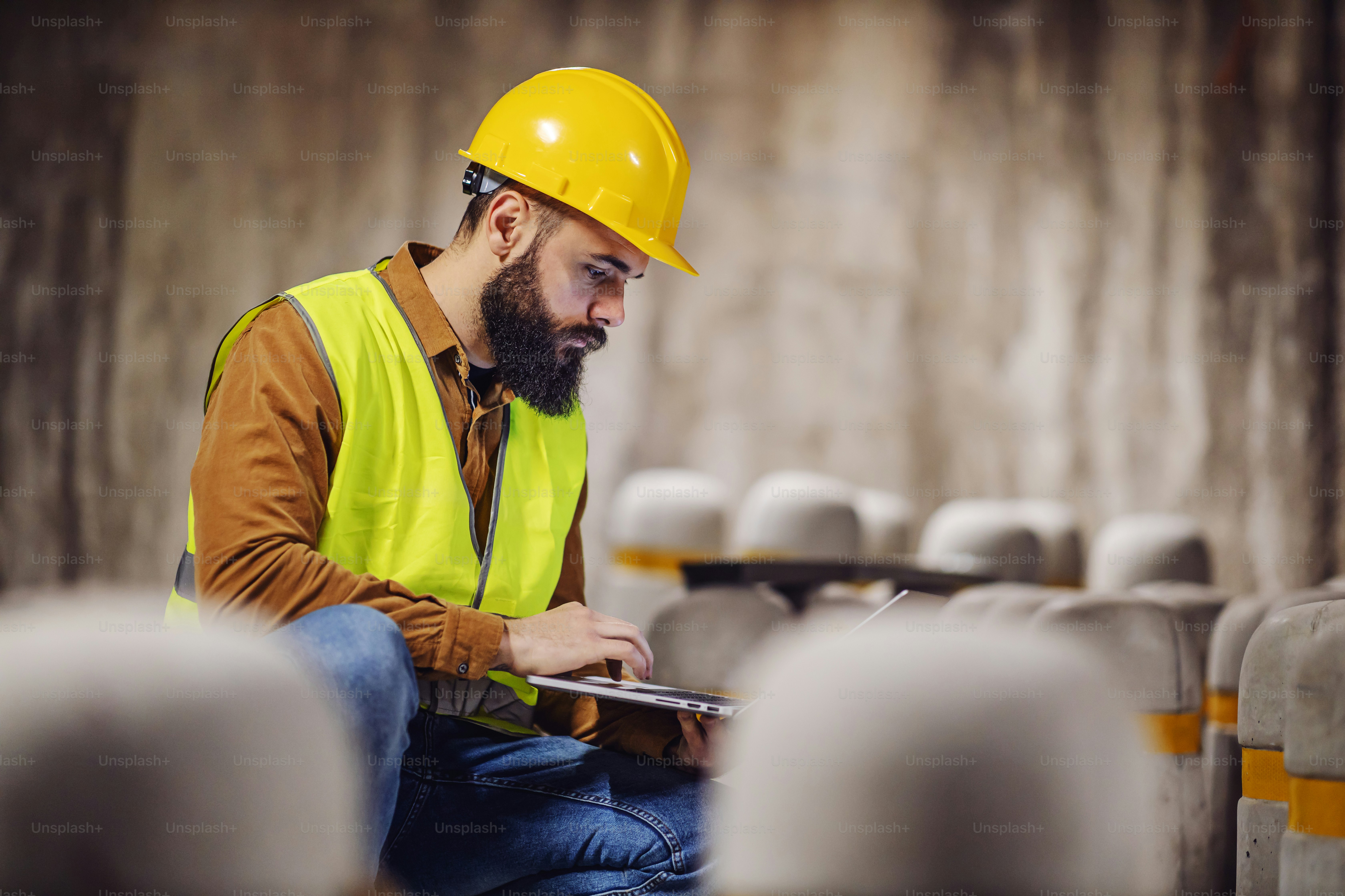 Young attractive supervisor crouching inside of underground garage and ...