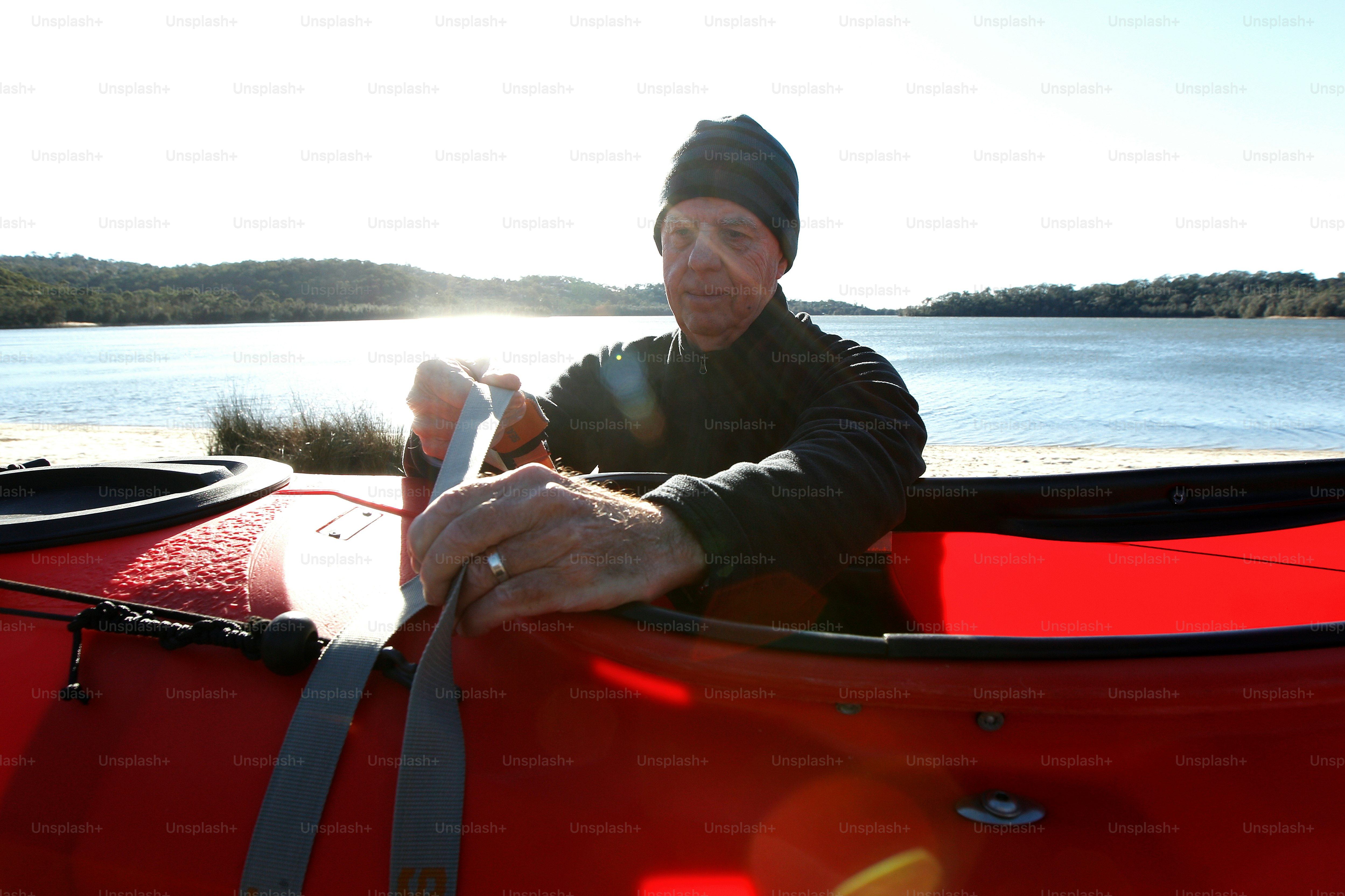 A man sitting in a red canoe on a sunny day photo – Outdoors Image on ...