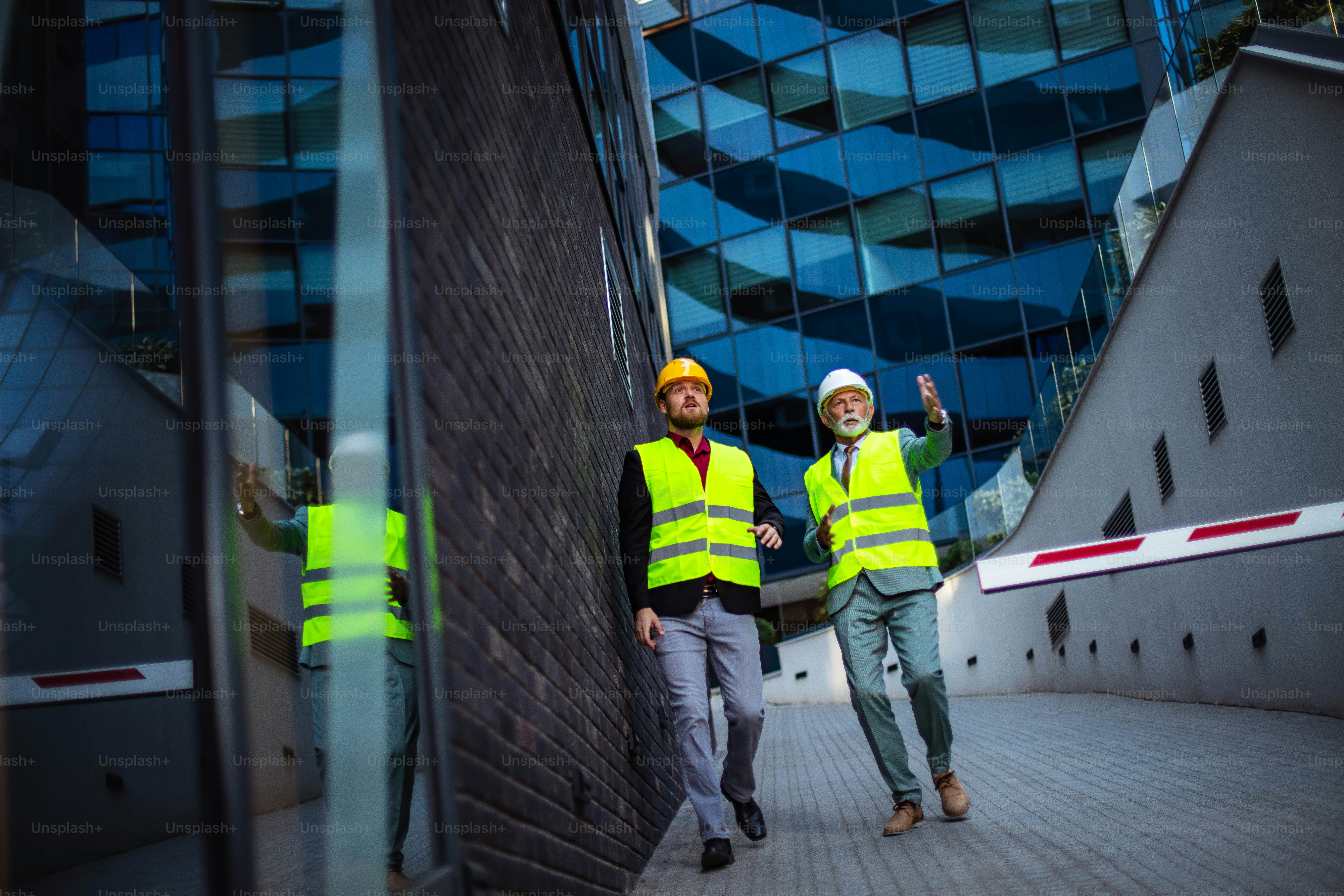 Mature engineer discussing the structure of the building with ...