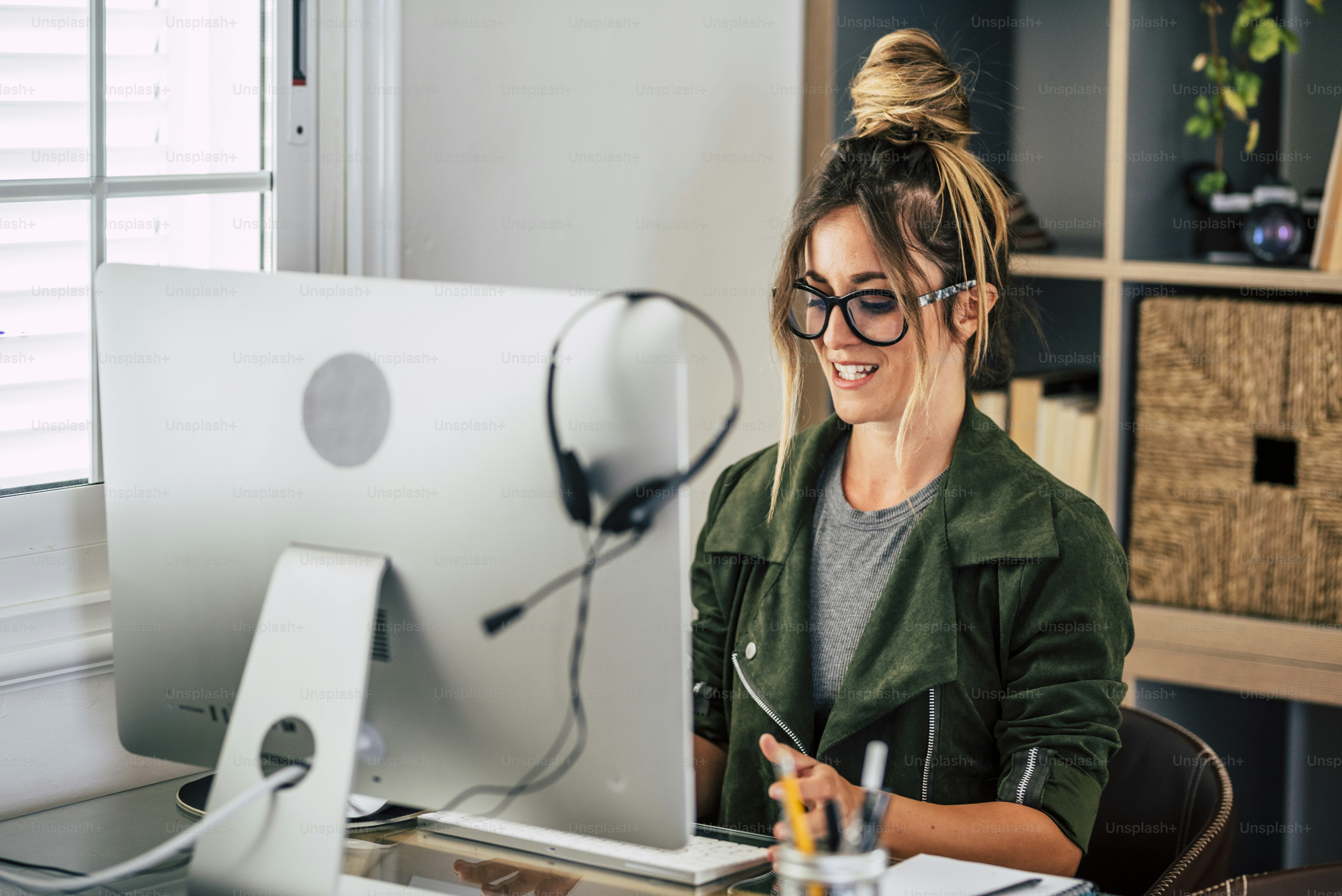 Happy adult young woman in video call conference at home in smart working free alternative ...