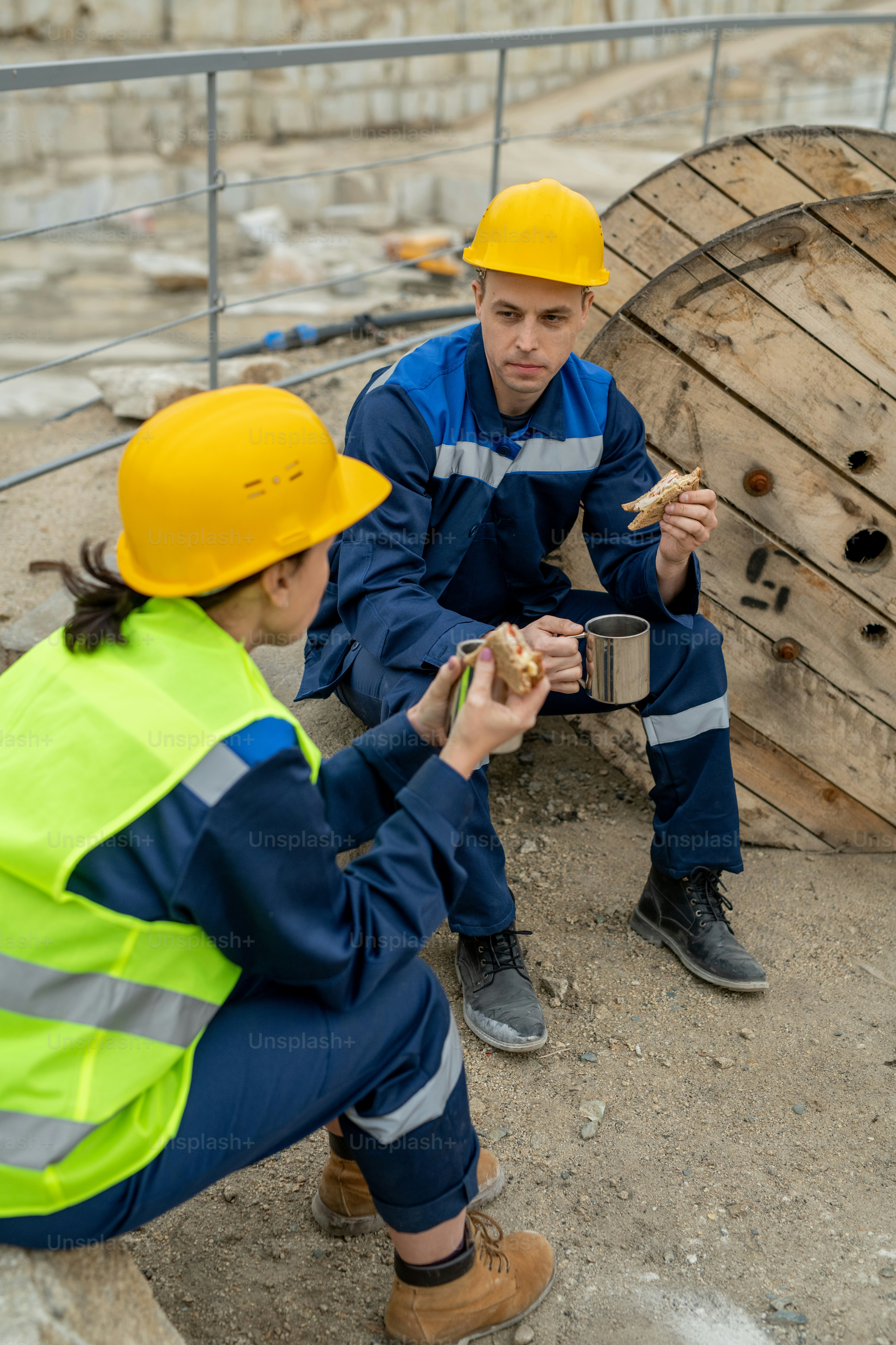 Two builders chatting and having lunch at break photo – Copy space ...