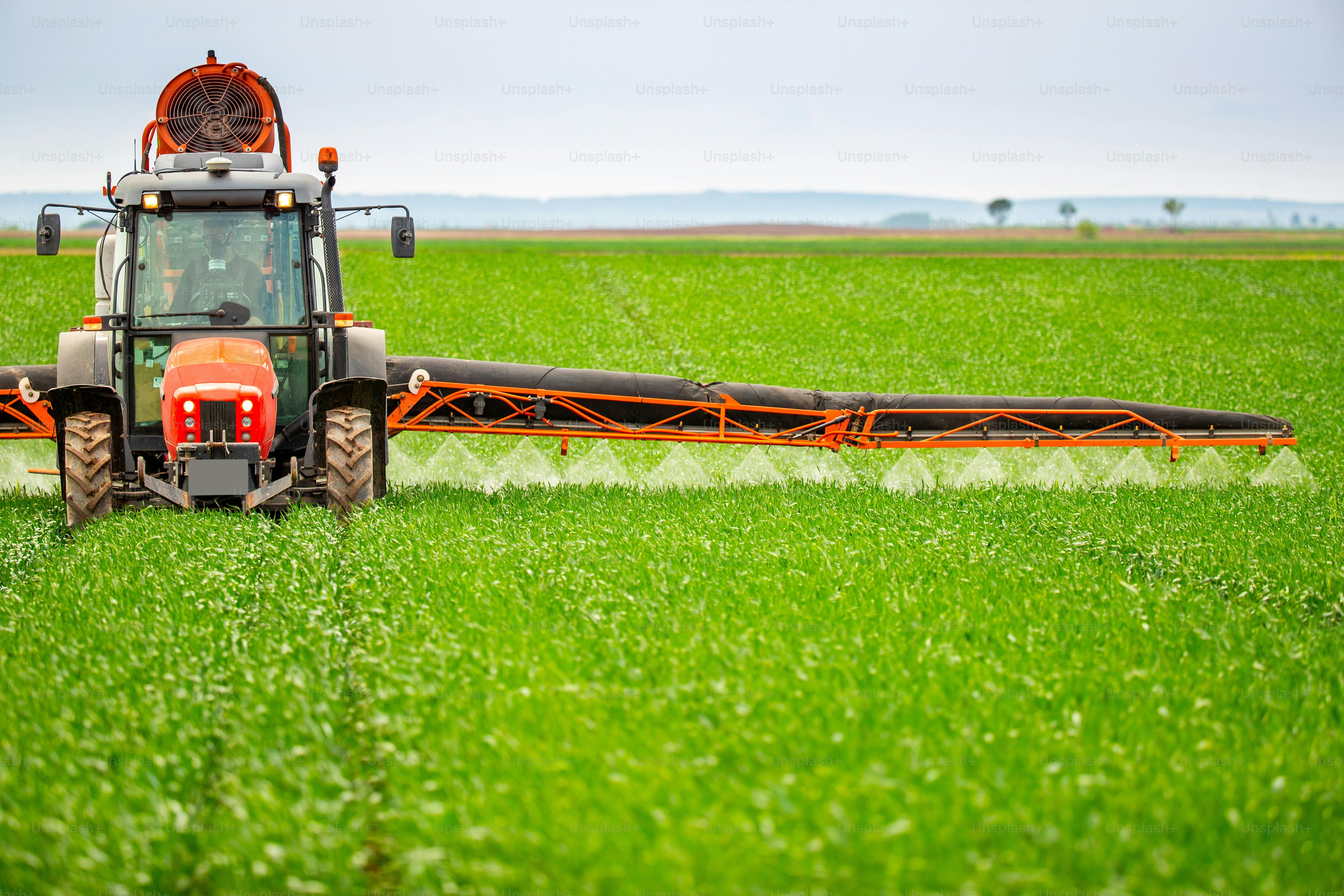 Farmer spraying wheat crops at field photo – Grass Image on Unsplash