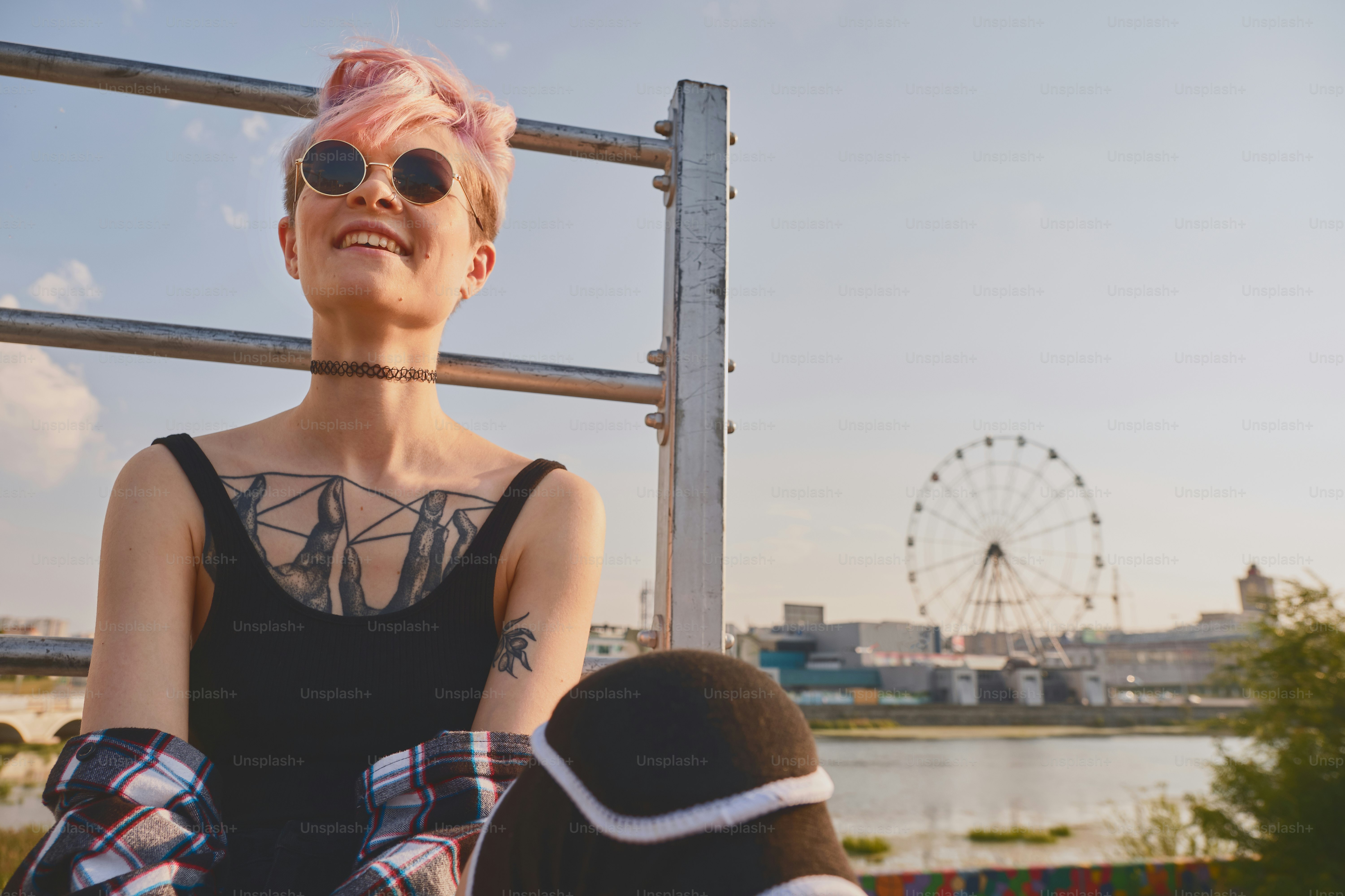 Portrait of daring young tattooed woman with short pink hair, open ...