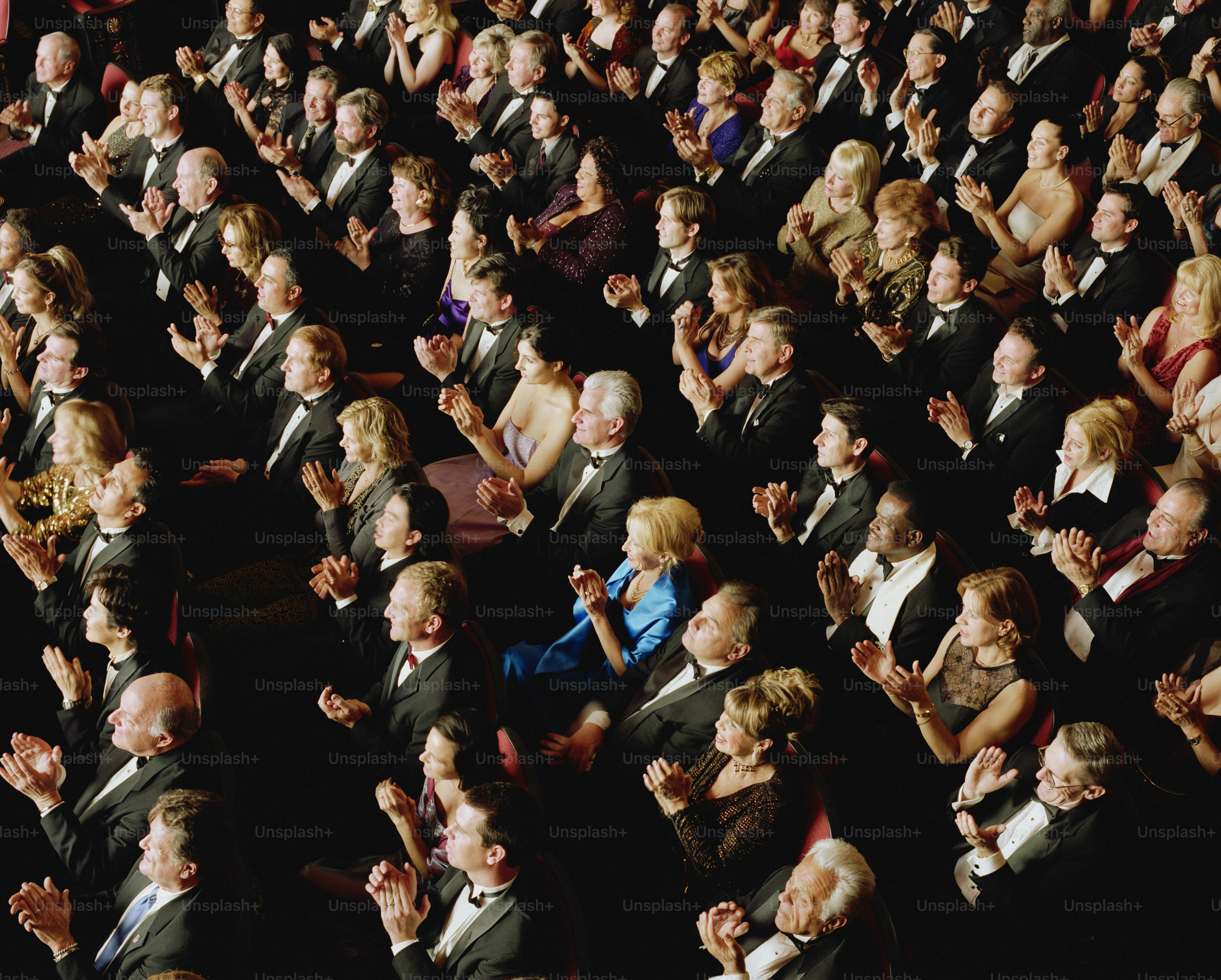 A crowd of people in suits and ties clapping photo – Adults only Image ...