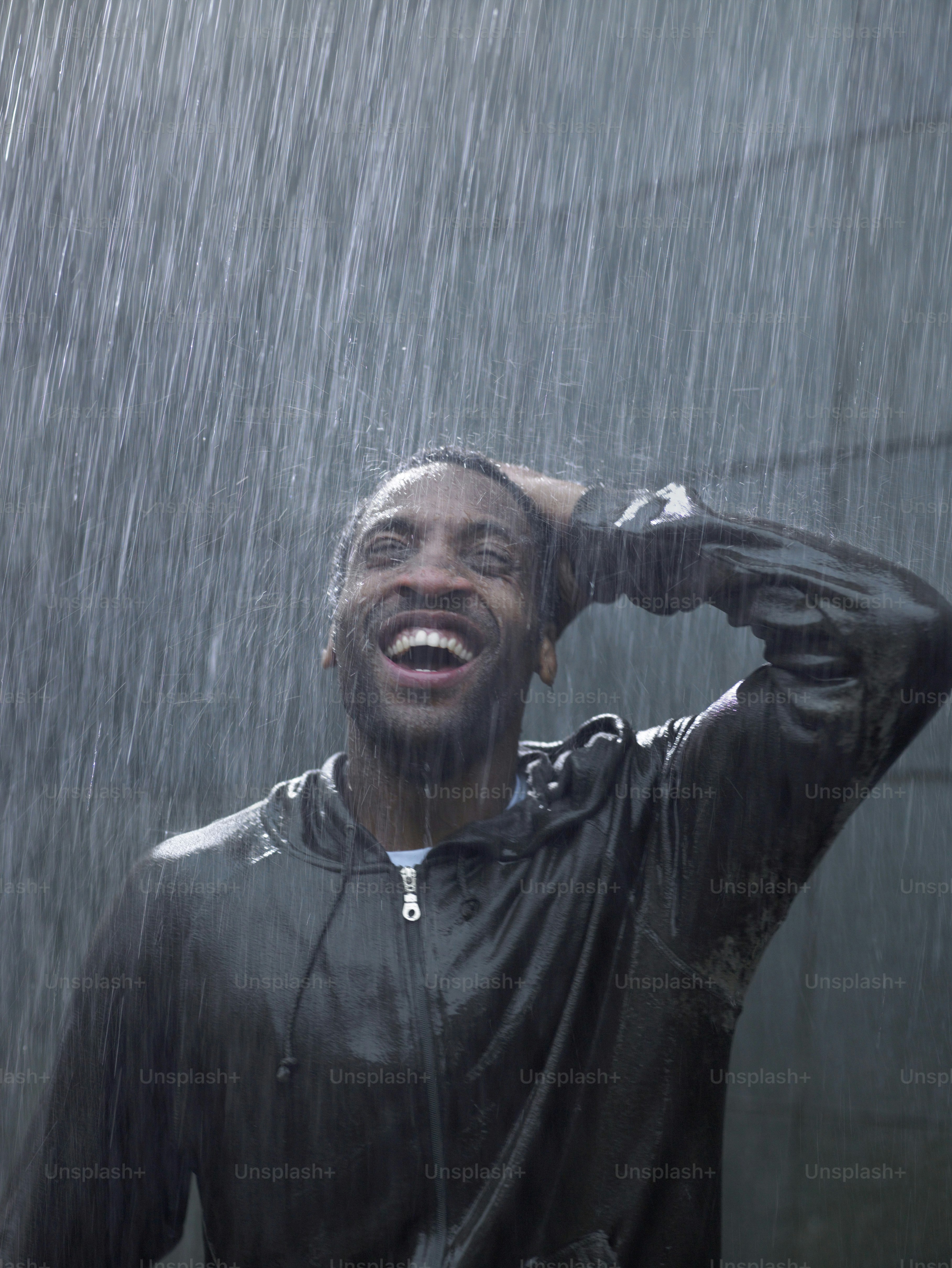 A man is laughing while standing in the rain photo – Reaction Image on ...