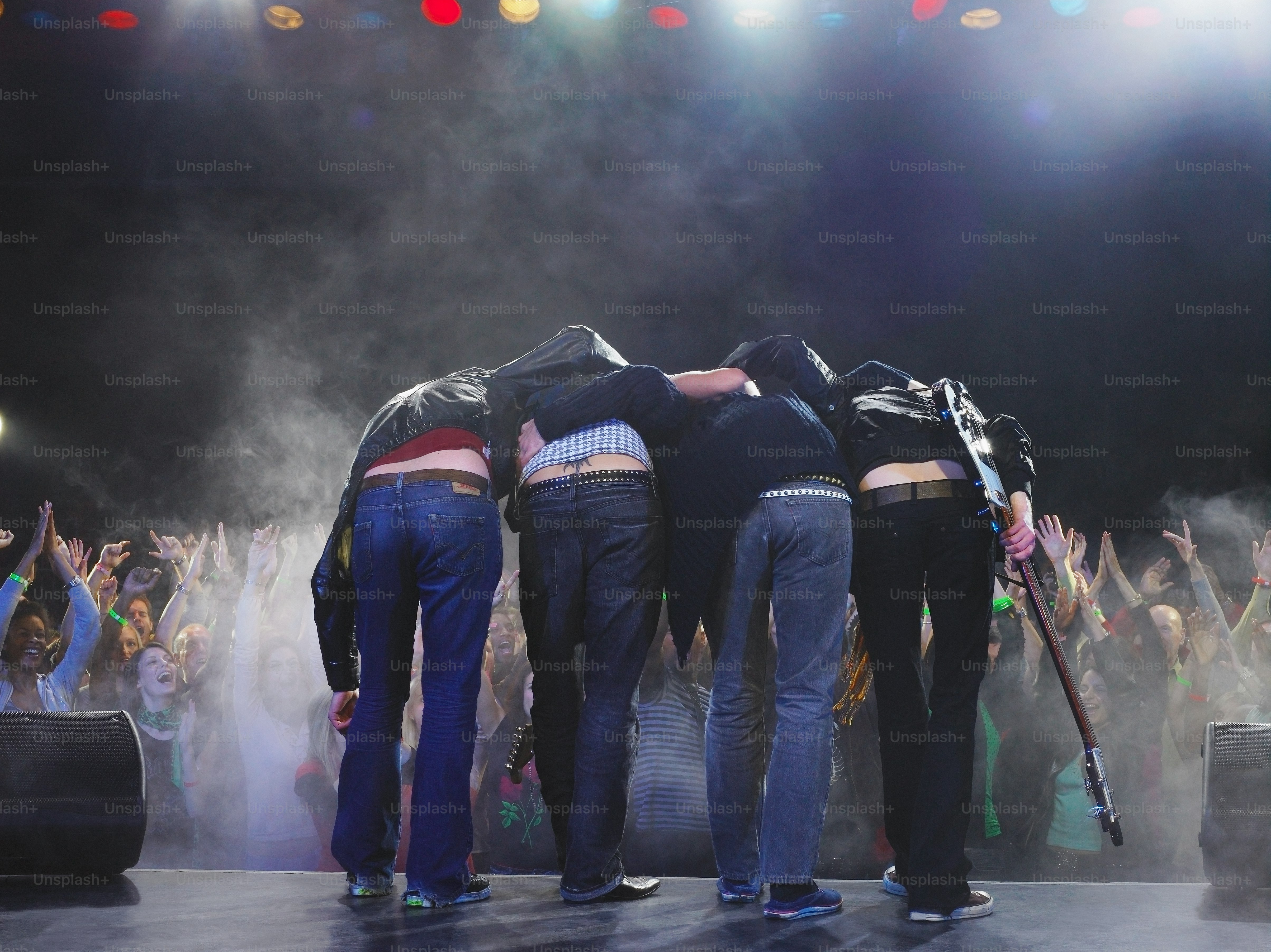 A group of people standing on top of a stage photo – Bowing Image on ...