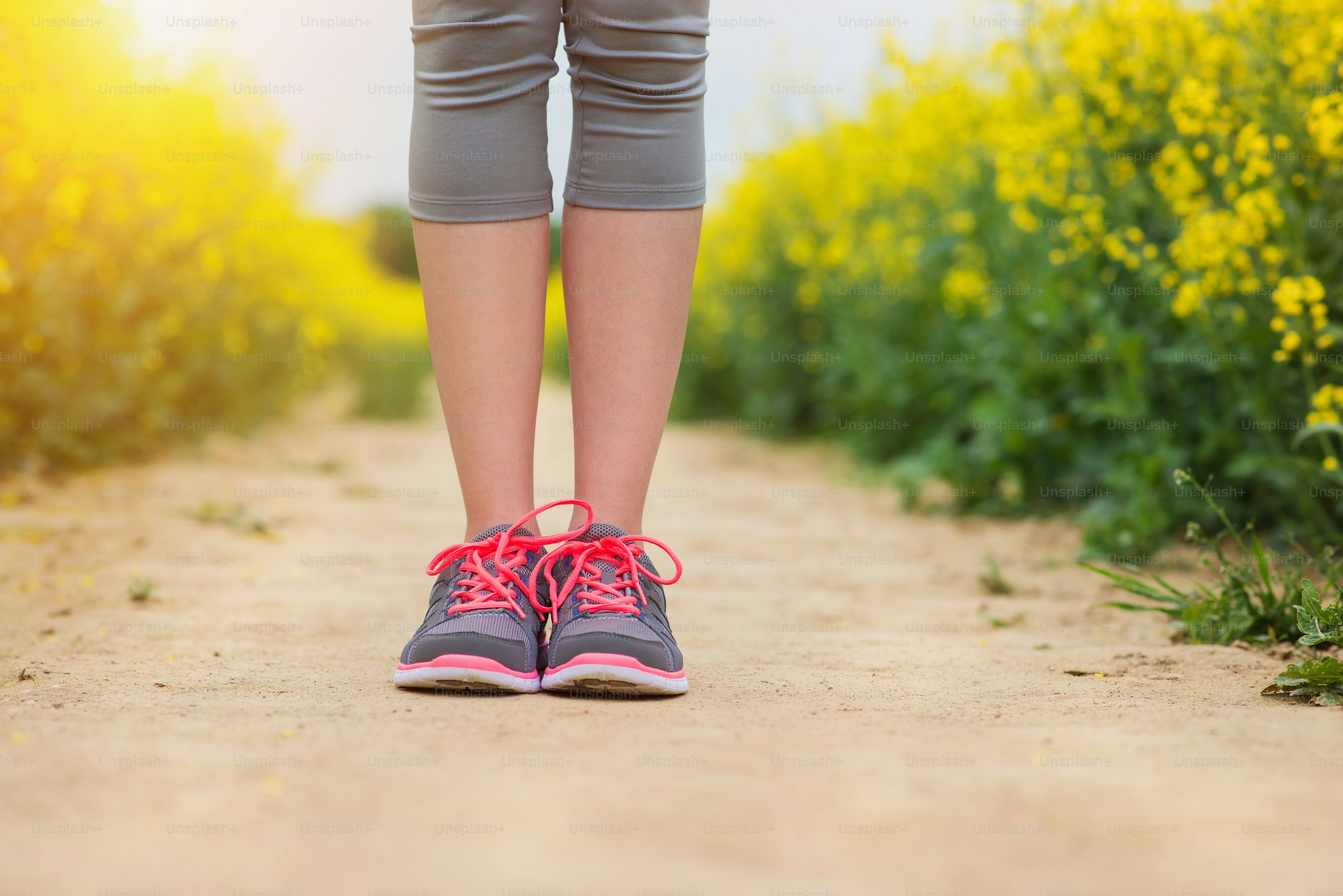 Beautiful woman running outside in spring canola field photo ...
