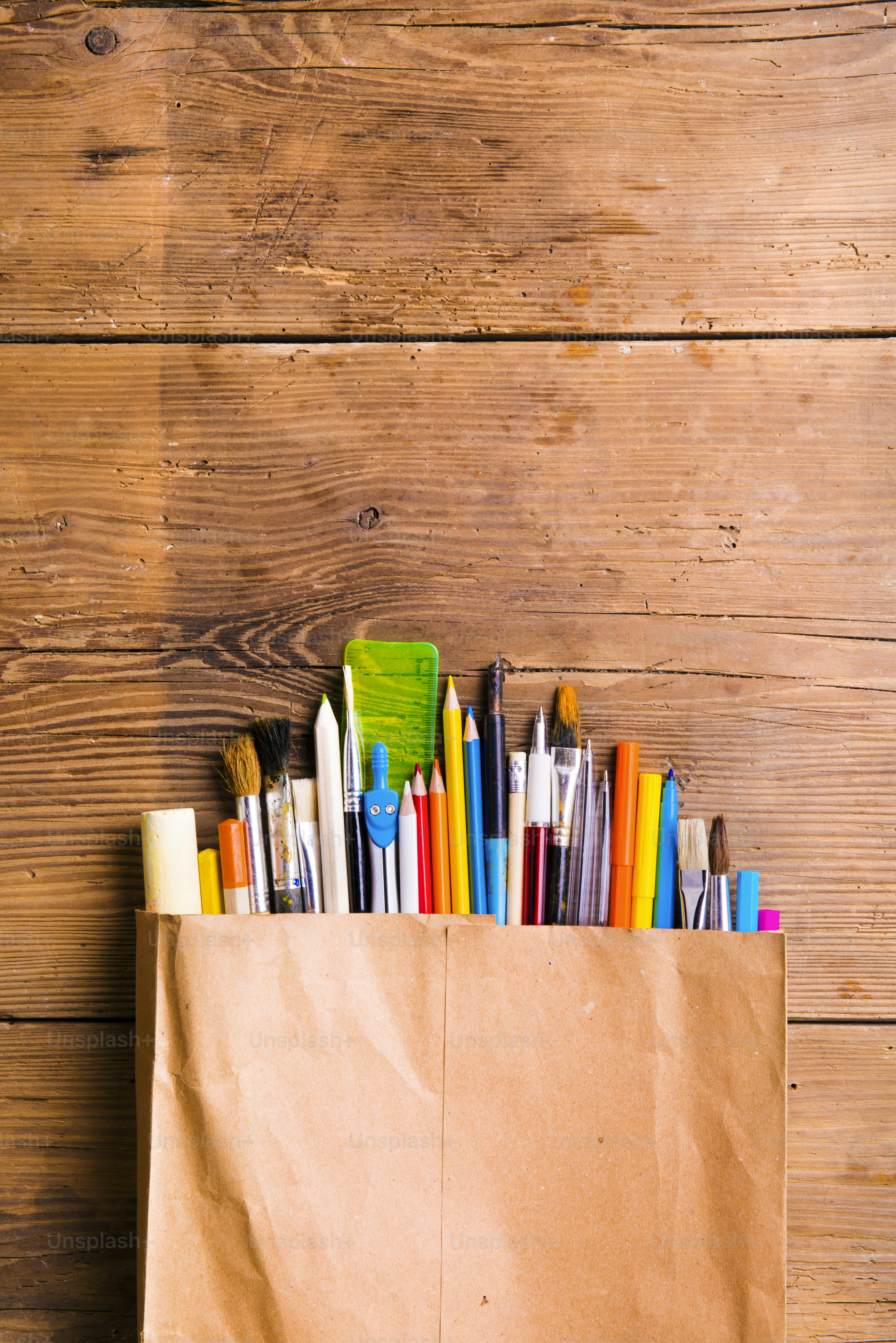 Desk with stationary. Studio shot on wooden background. photo ...