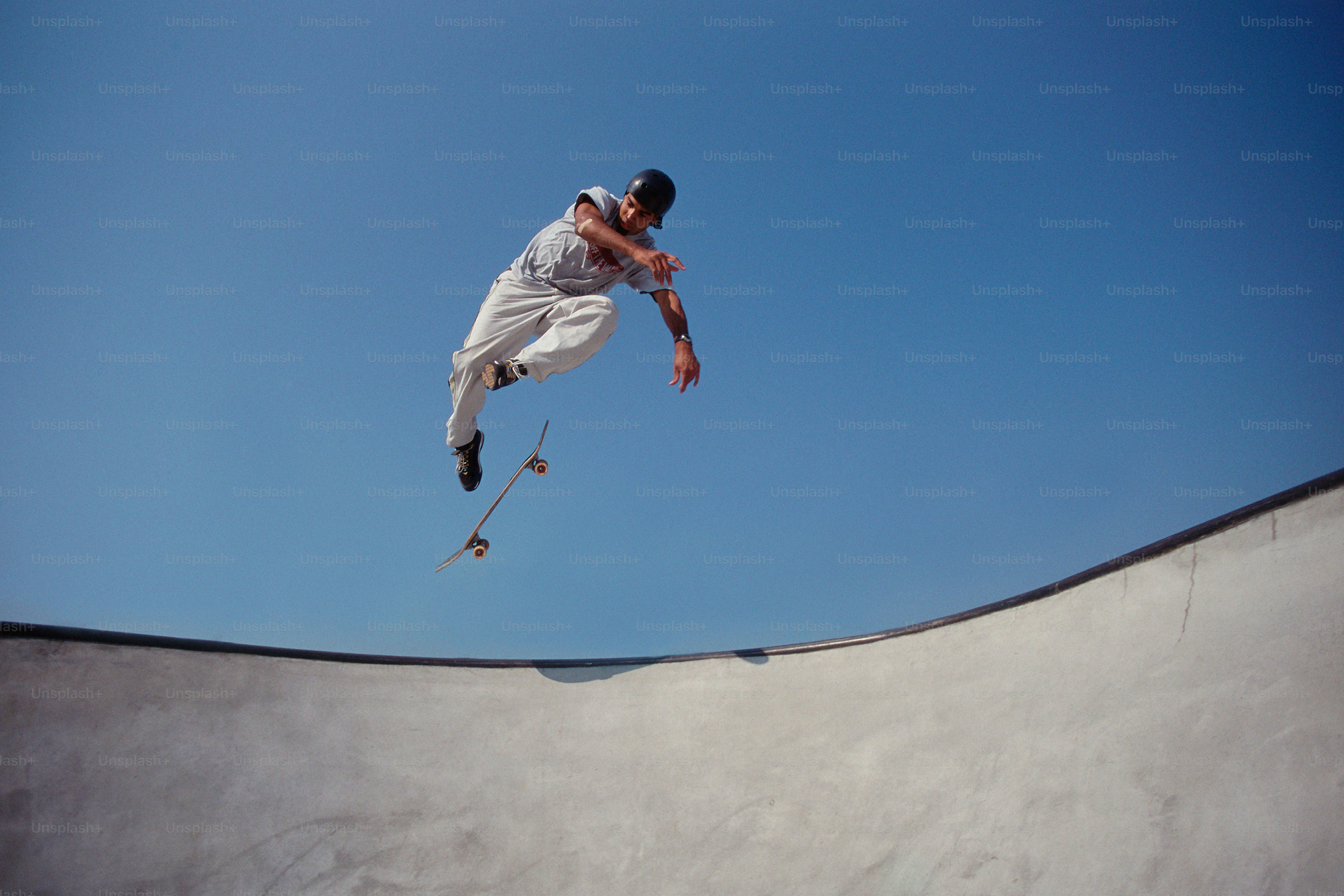 A man flying through the air while riding a skateboard photo – Season ...