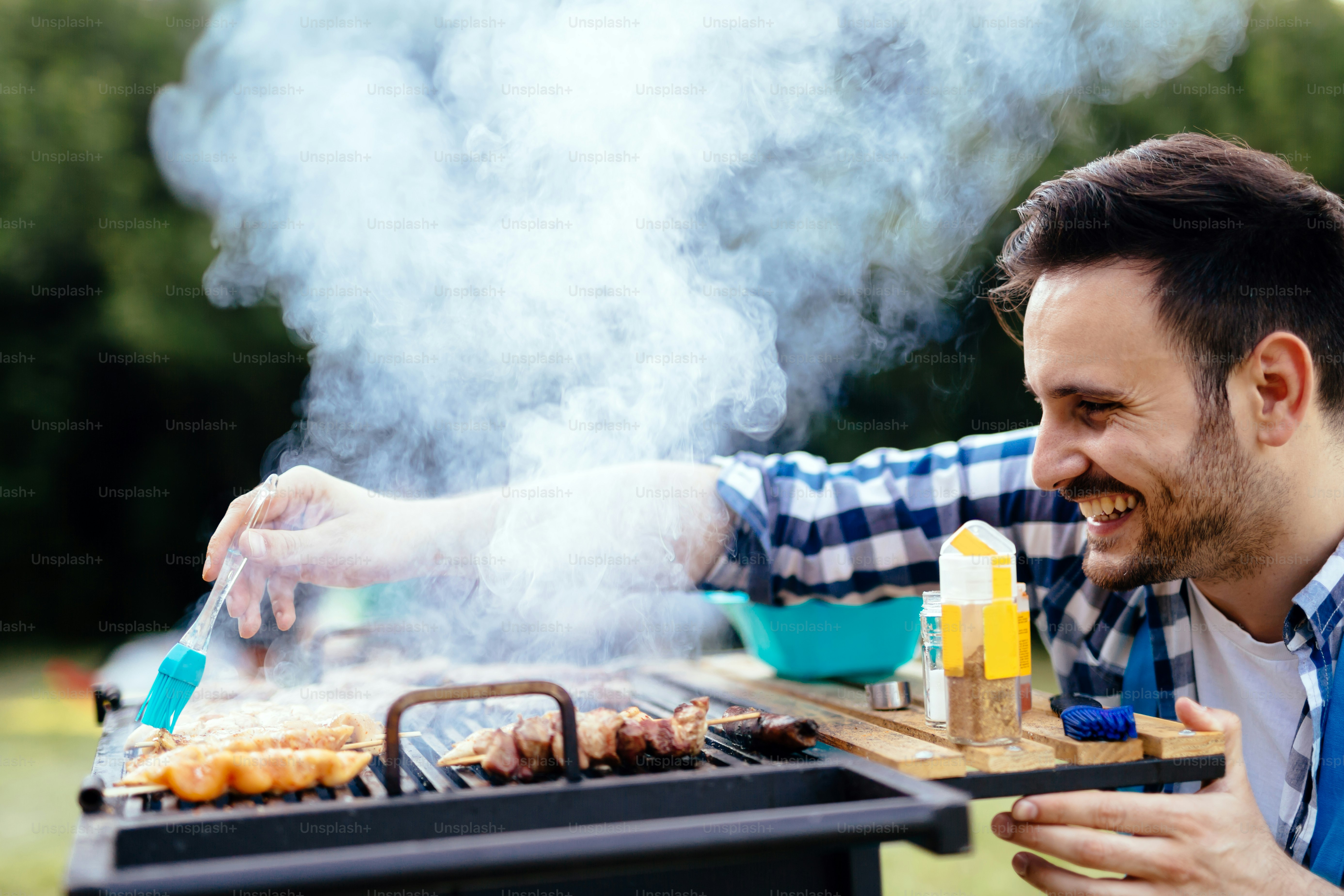 Barbecue spices and seasonings being added to meat photo – Food Image ...