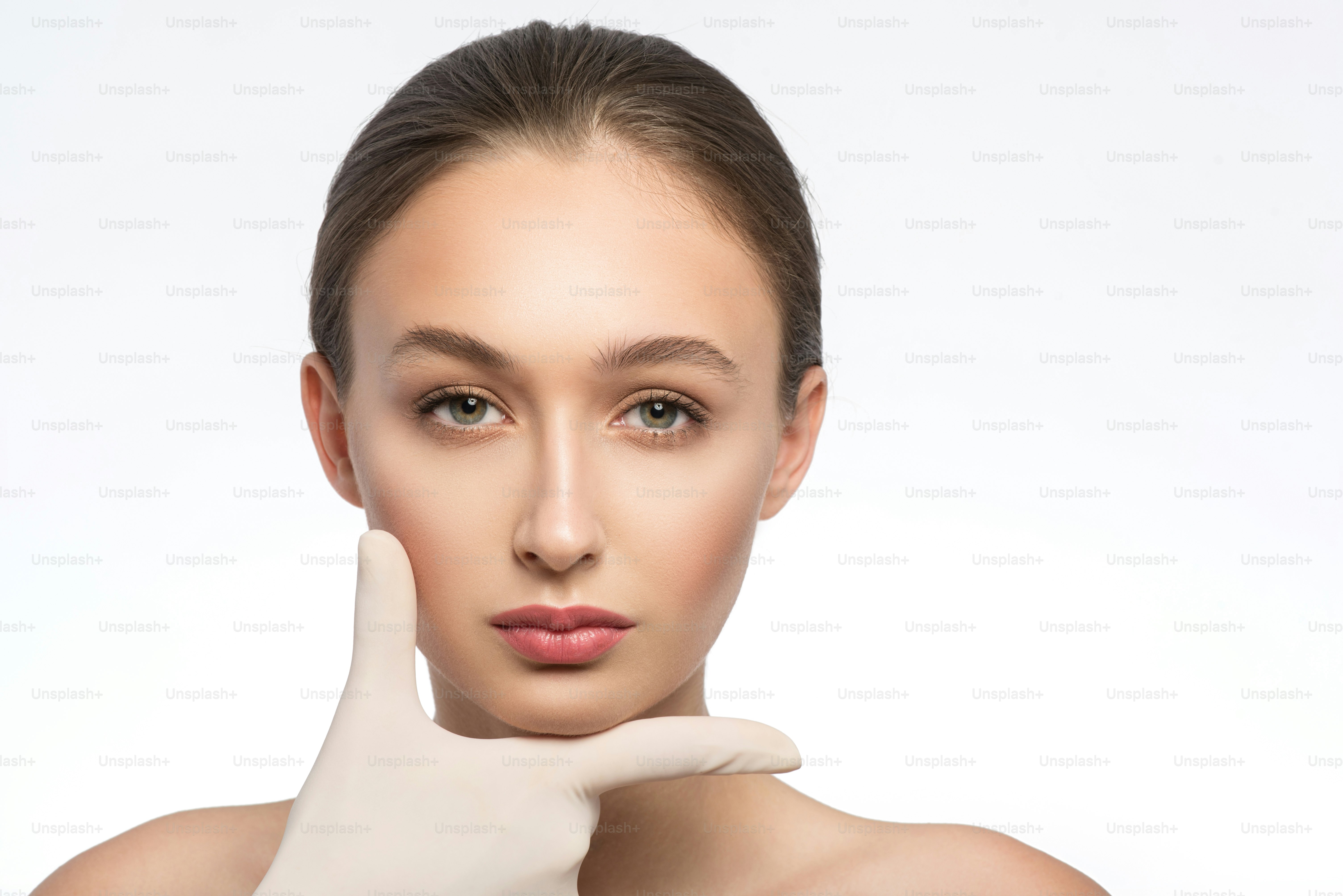 Beautiful girl has perfect face proportion. She is standing and looking ...