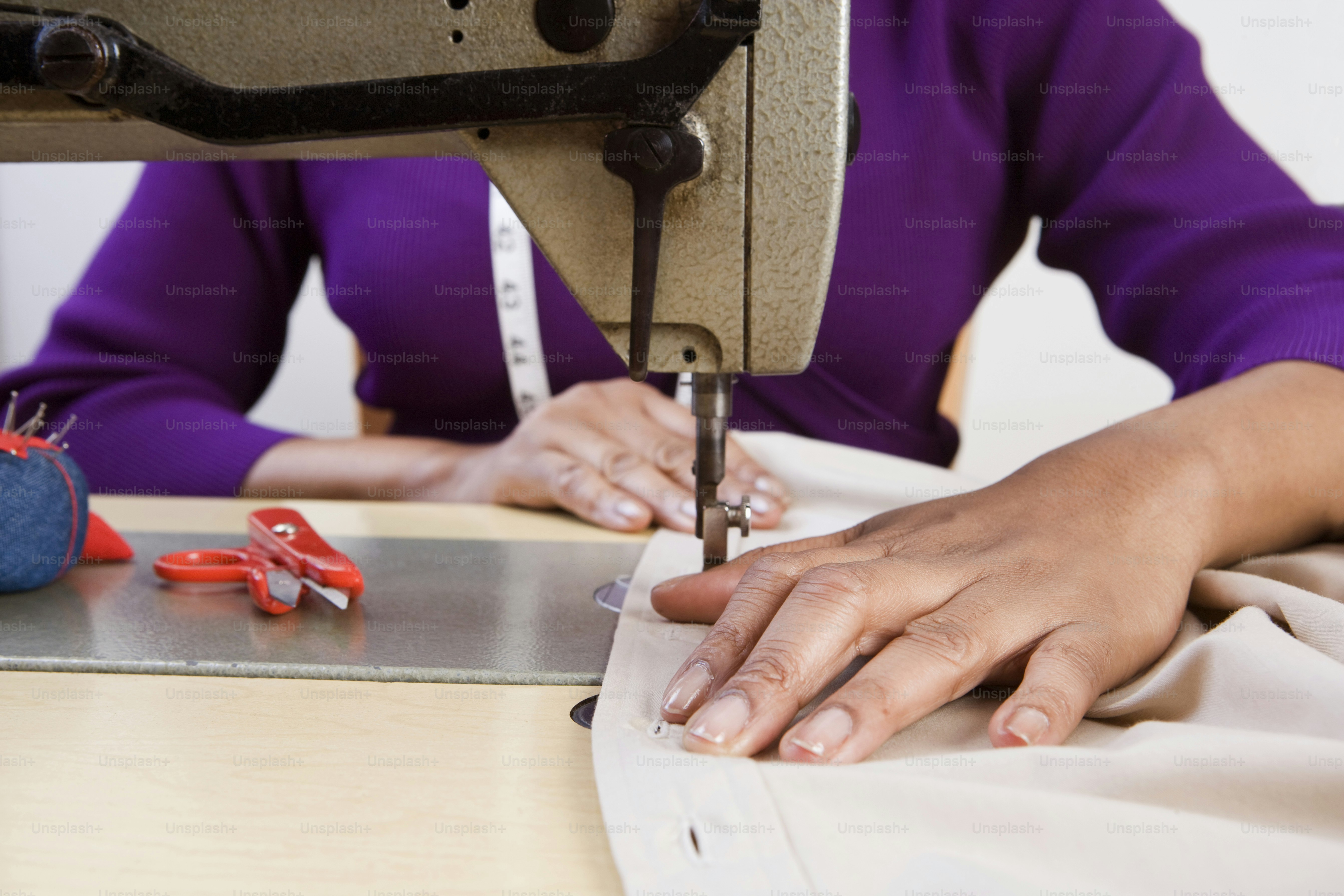 A woman working on a sewing machine photo – Human hand Image on Unsplash