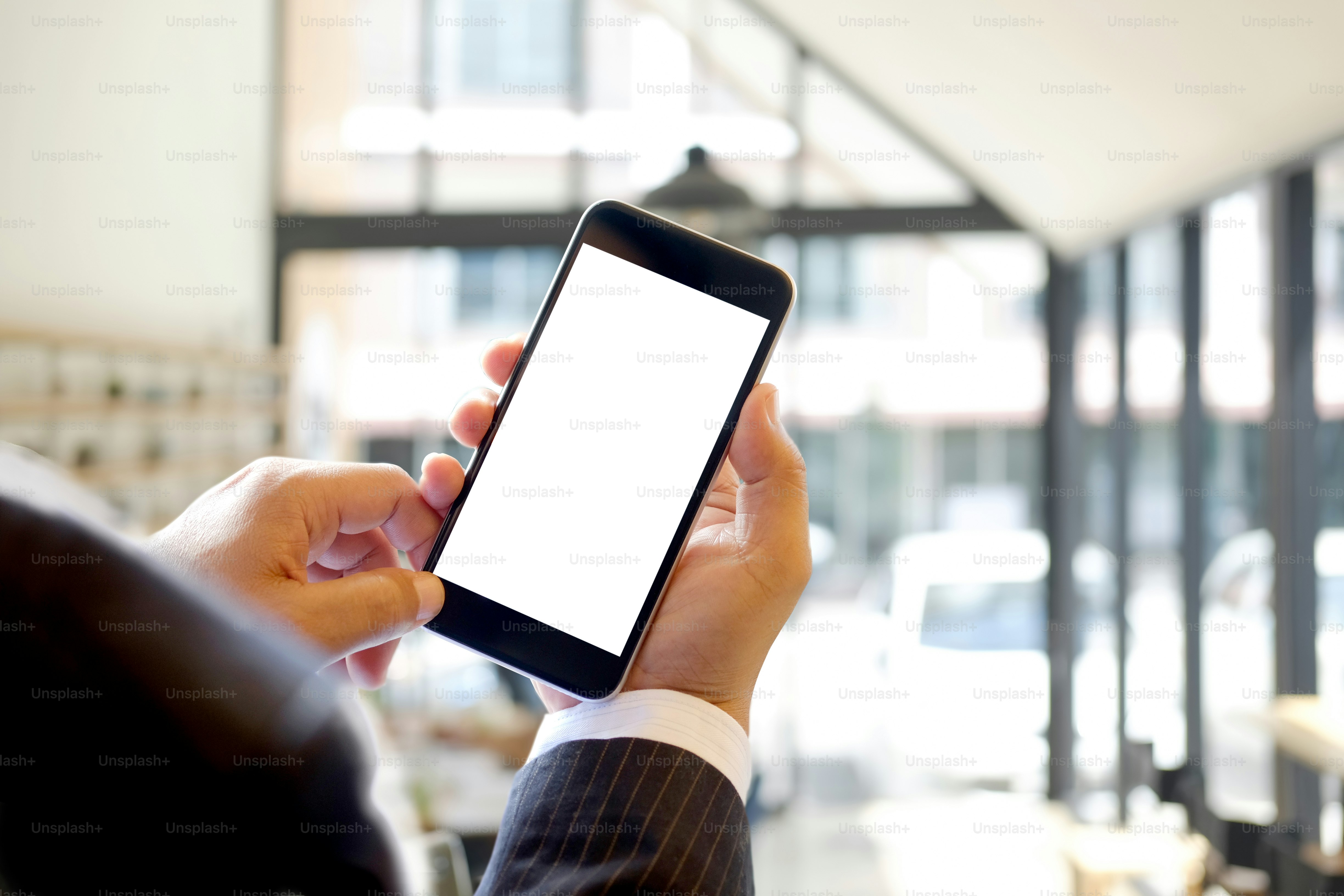 Businessman using mobile smartphone. Blank screen for graphic display ...