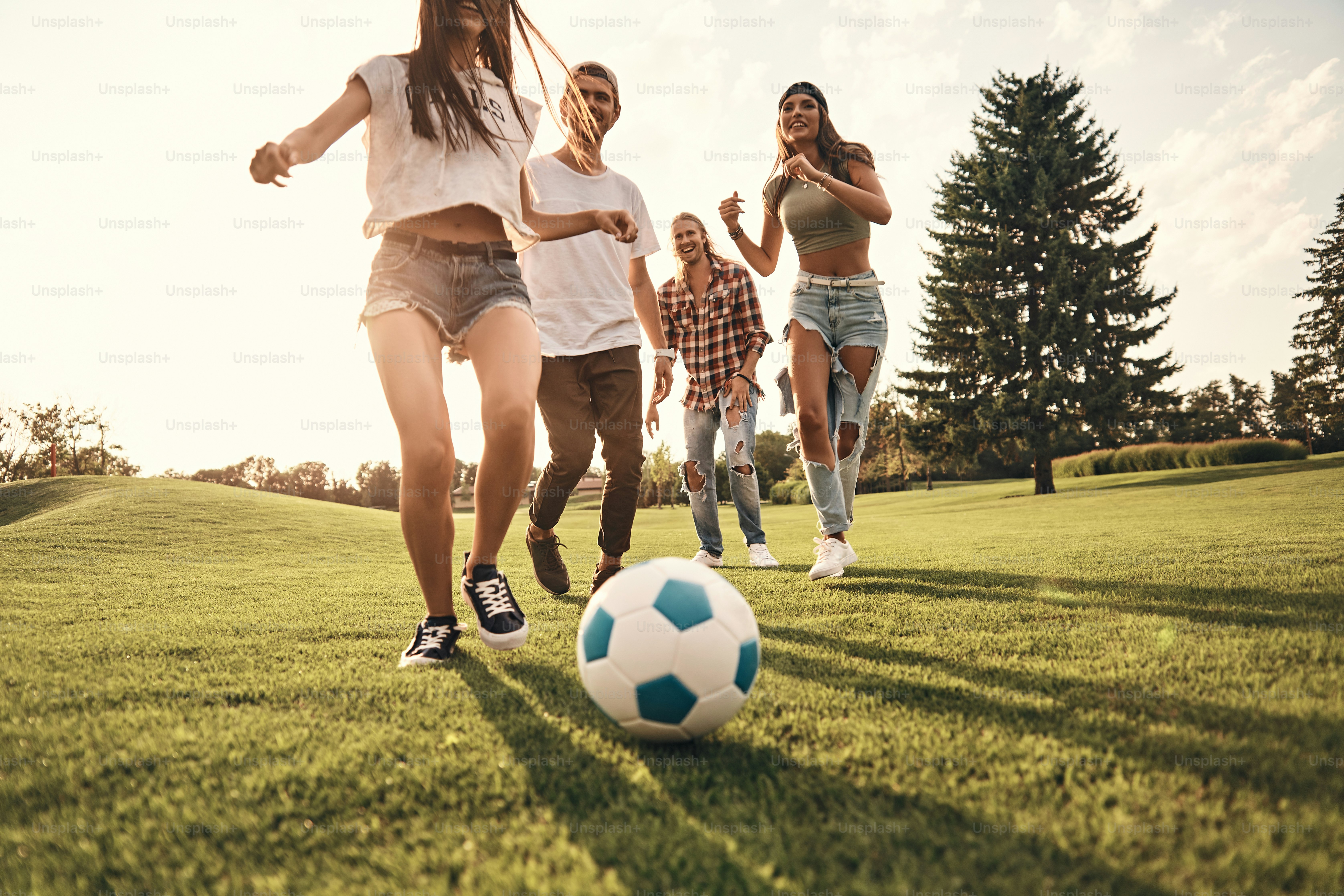 Group of young smiling people in casual wear running while playing ...