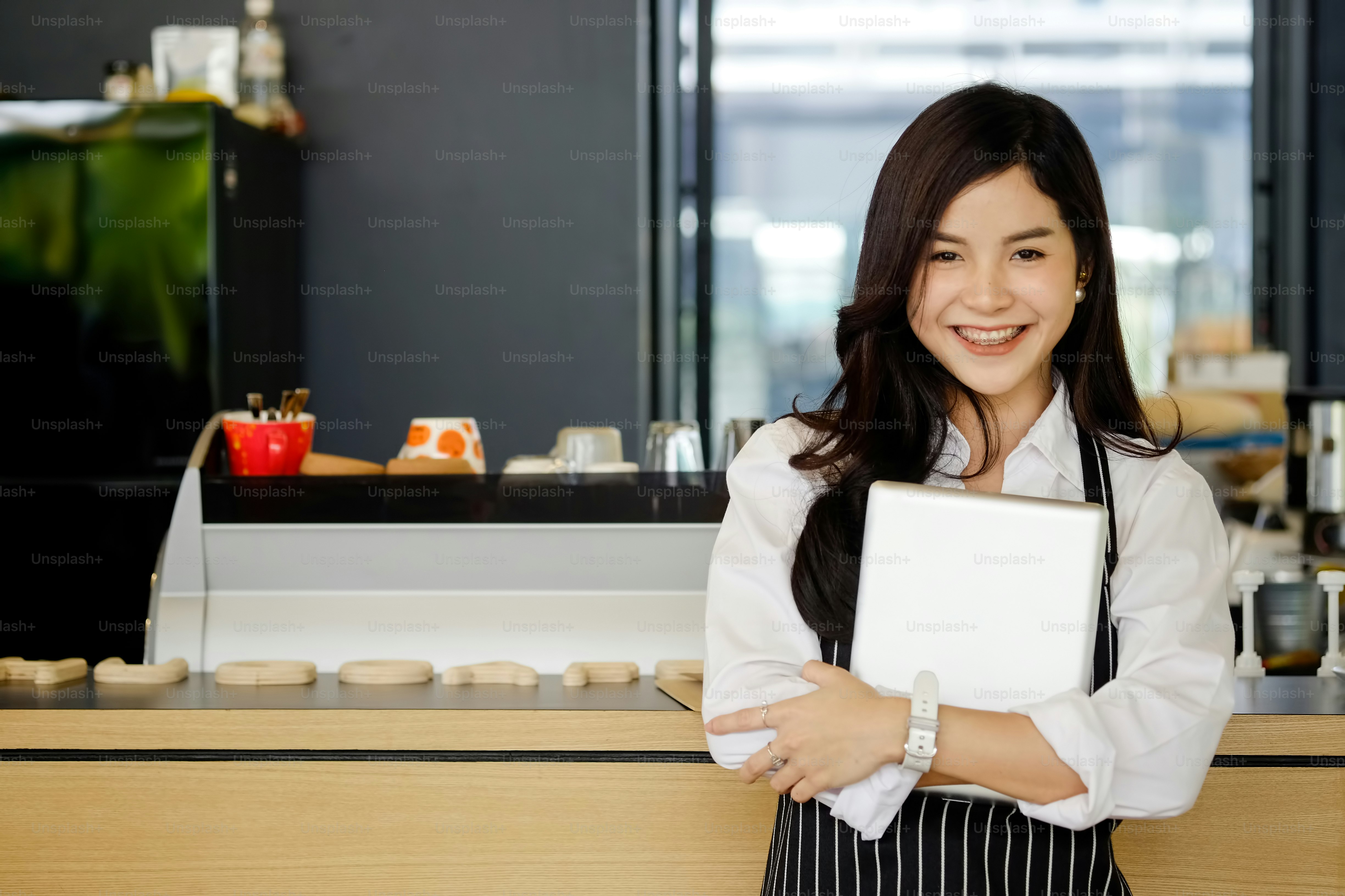 Portrait of Young Asian confident barista entrepreneur tanding behind ...