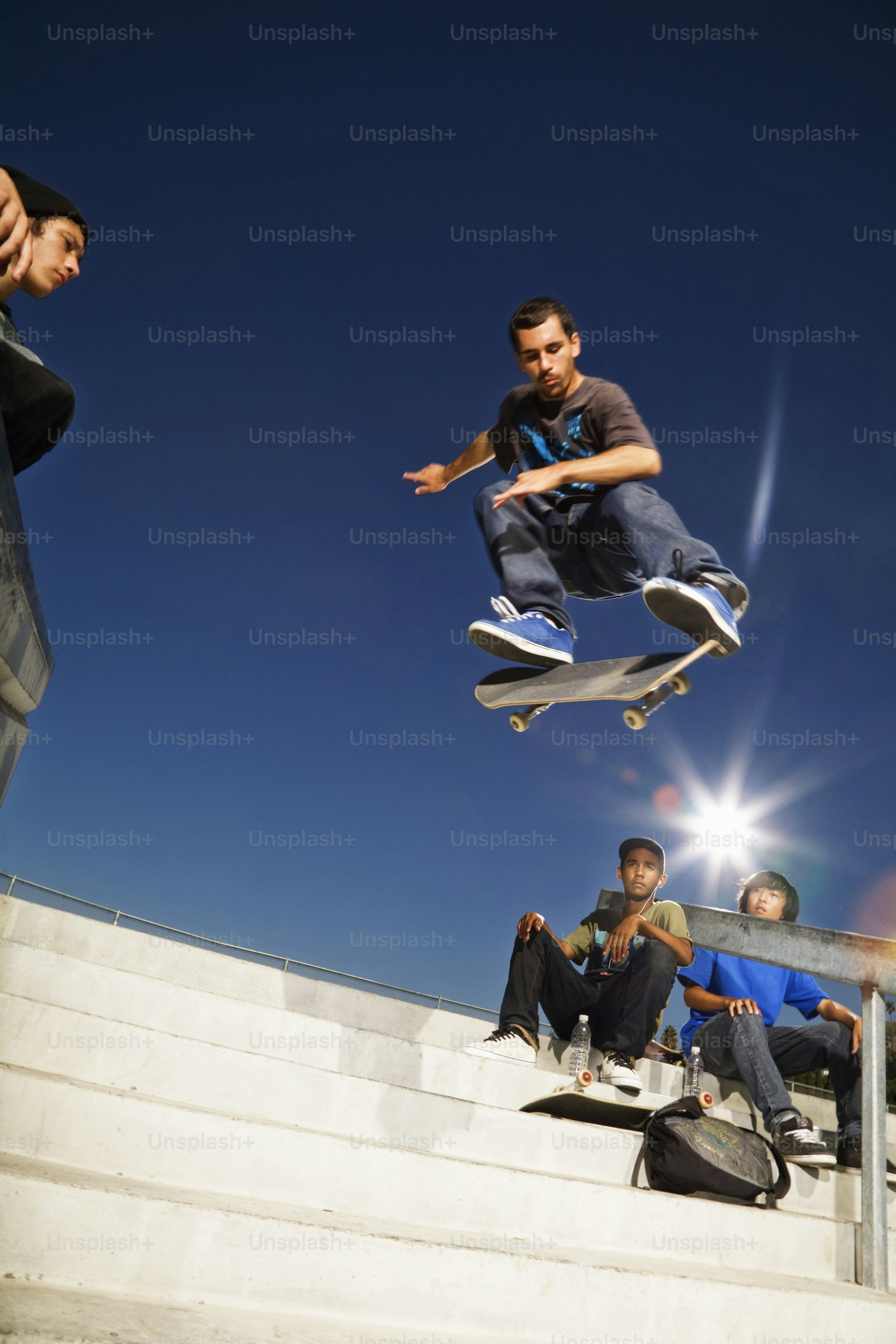 A man flying through the air while riding a skateboard photo ...