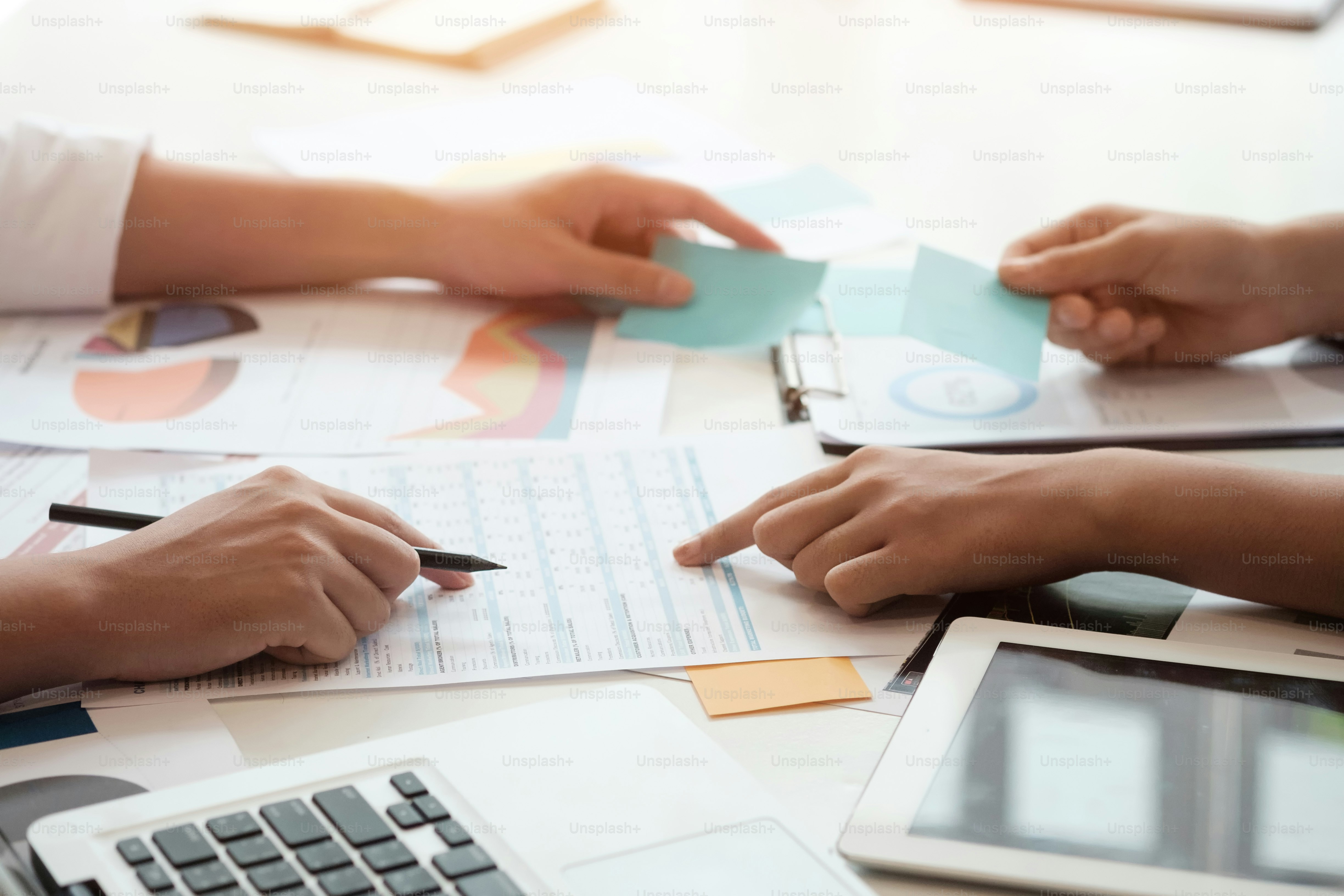 Business analysis hands pointing data paper and consulting with closeup ...