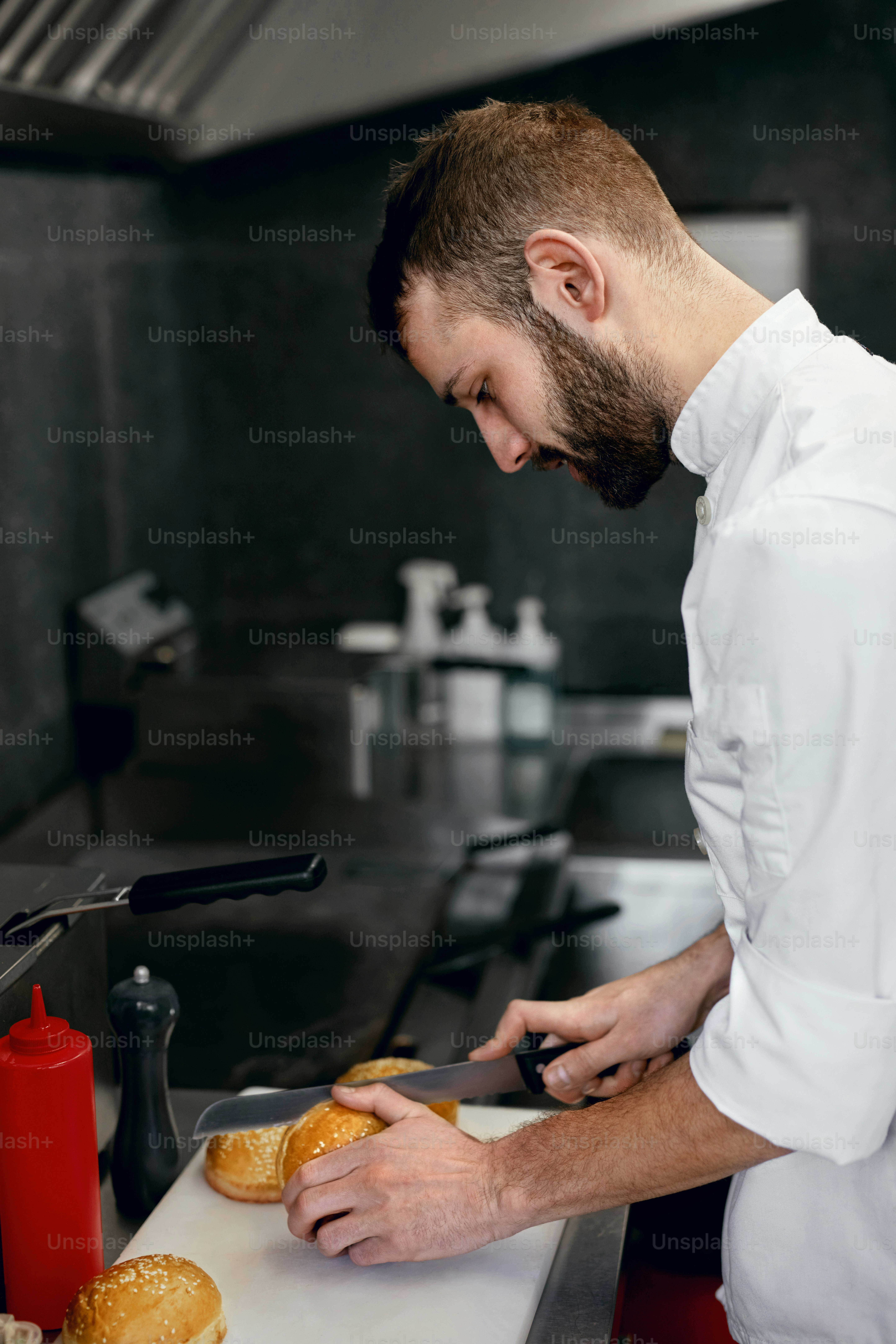 Chef Cooking Burgers In Restaurant Kitchen, Cutting Buns. High ...