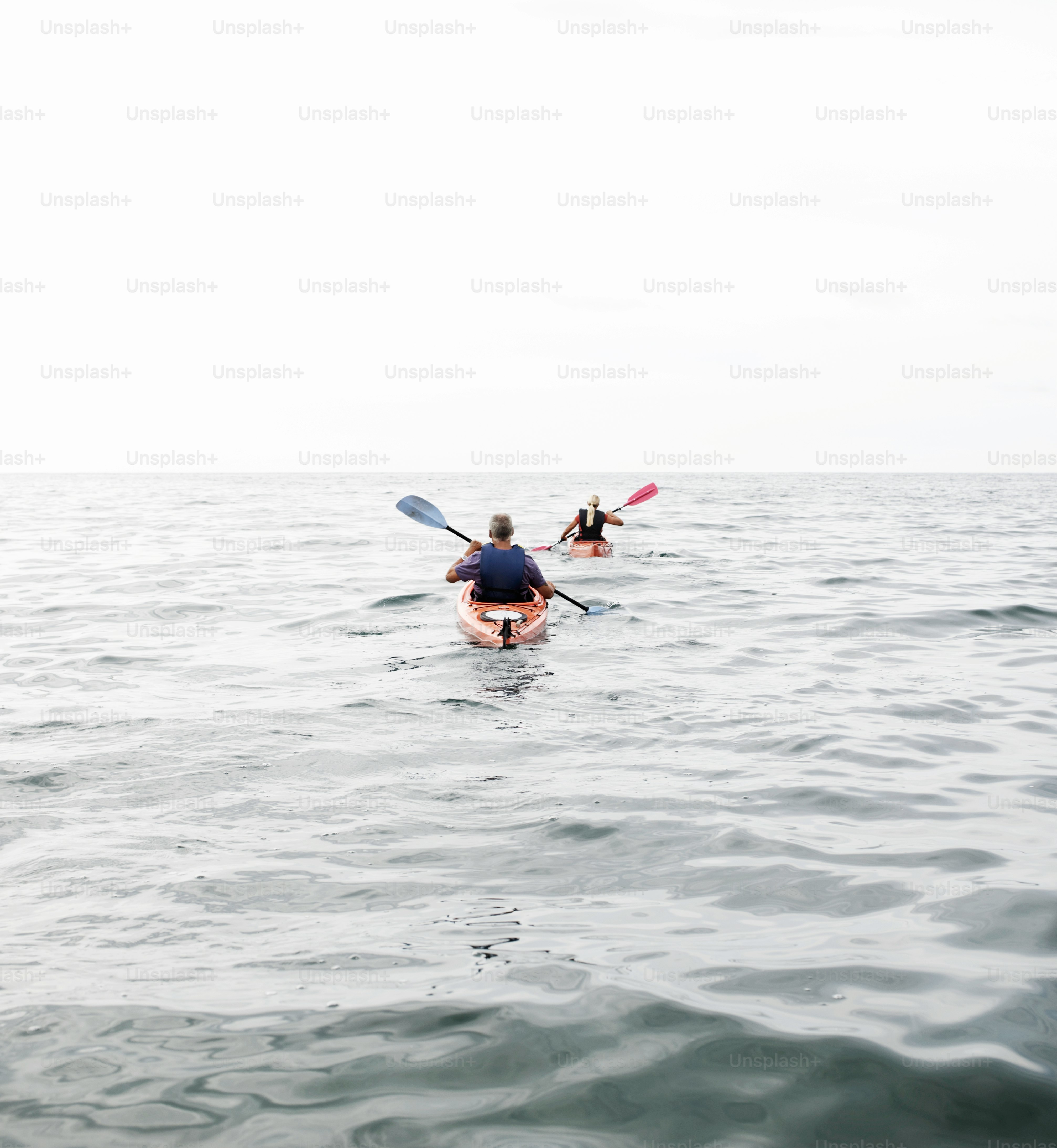 Two people in kayaks paddling in the ocean photo – Kayak Image on Unsplash
