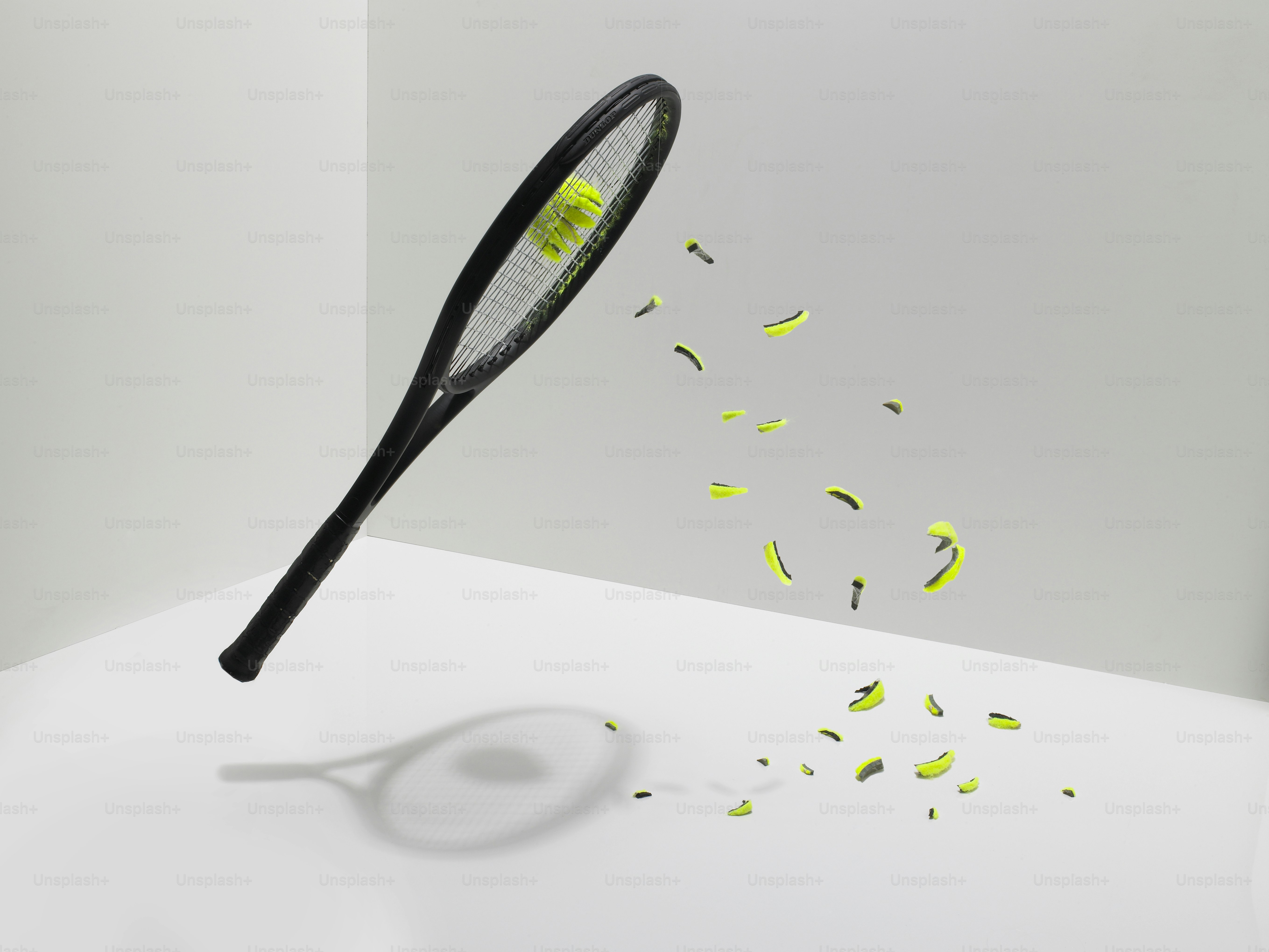 A tennis racquet hitting a tennis ball with it's back end photo ...