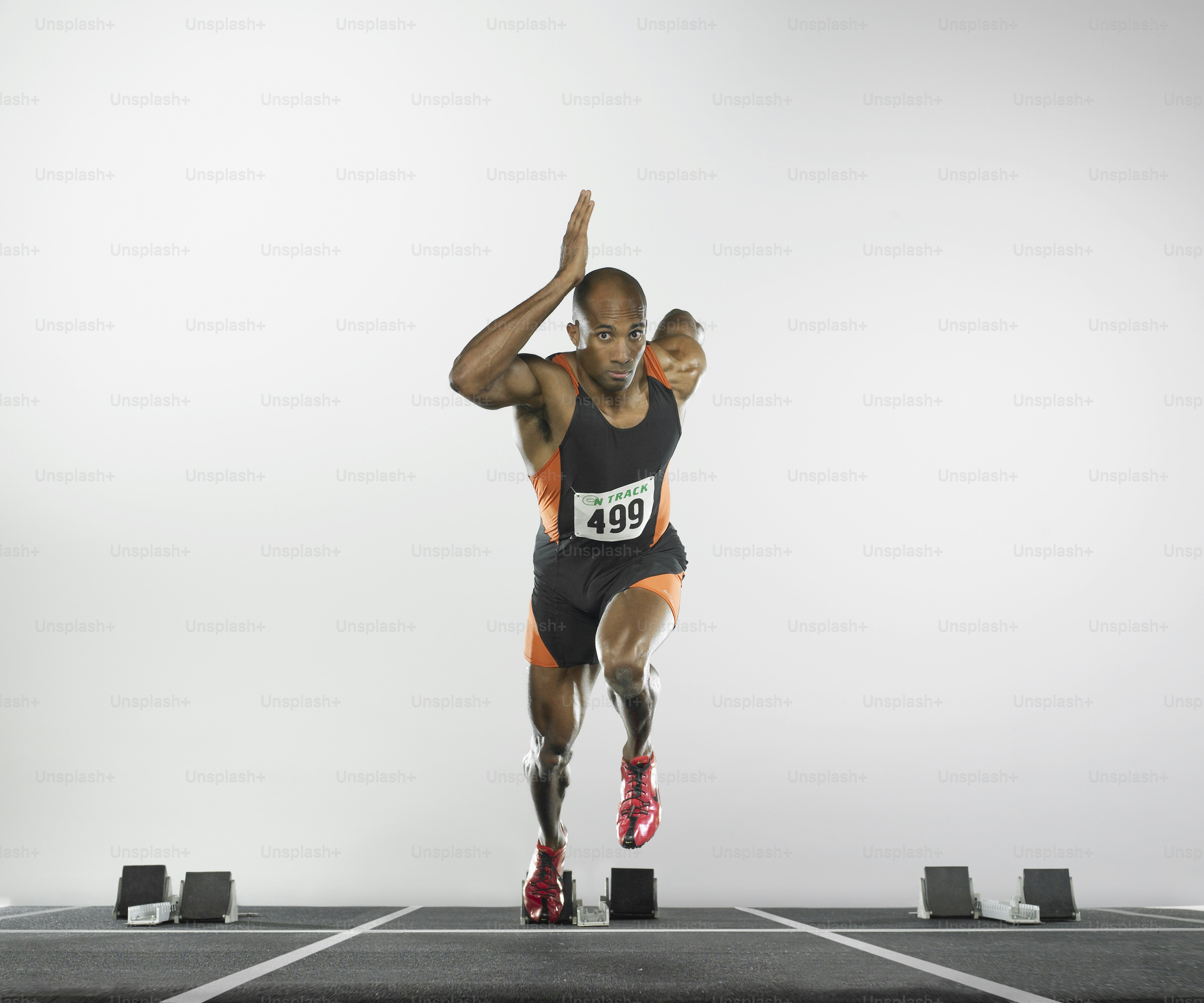 A man is running on a race track photo – Running Image on Unsplash