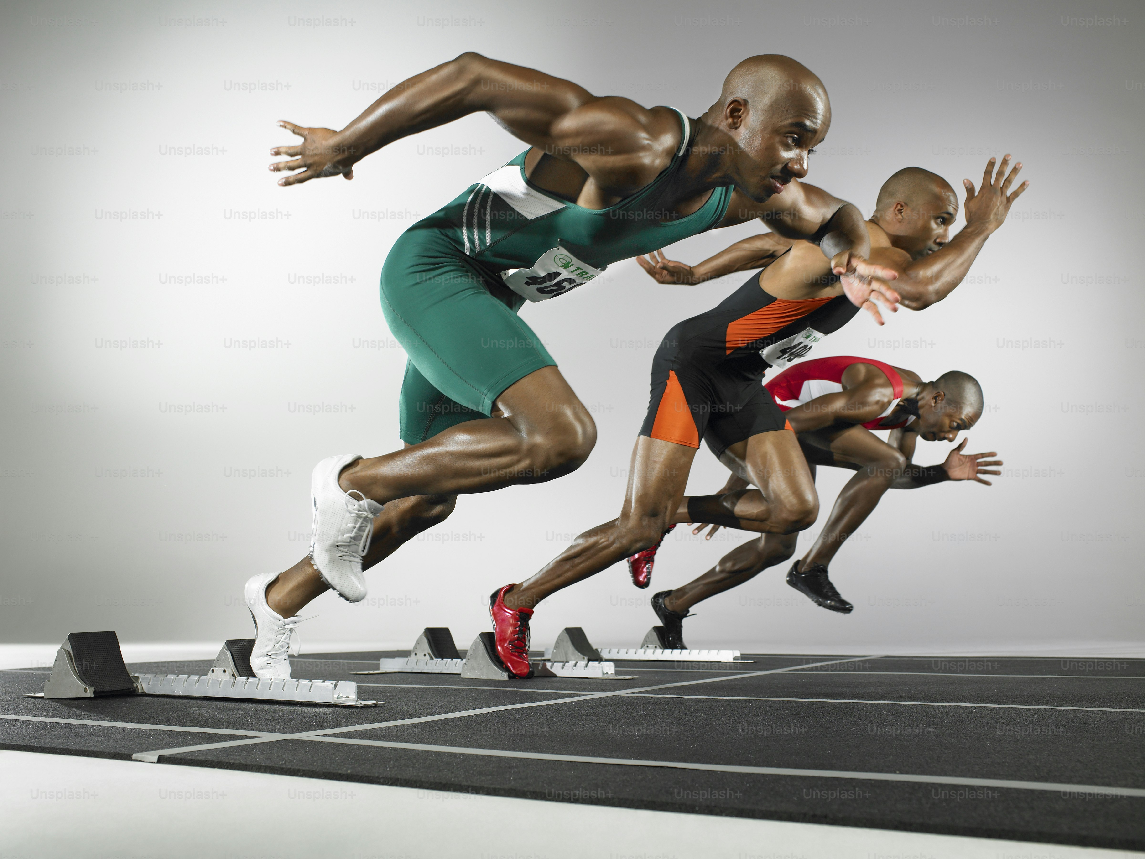 A group of men running on a track photo – Running Image on Unsplash