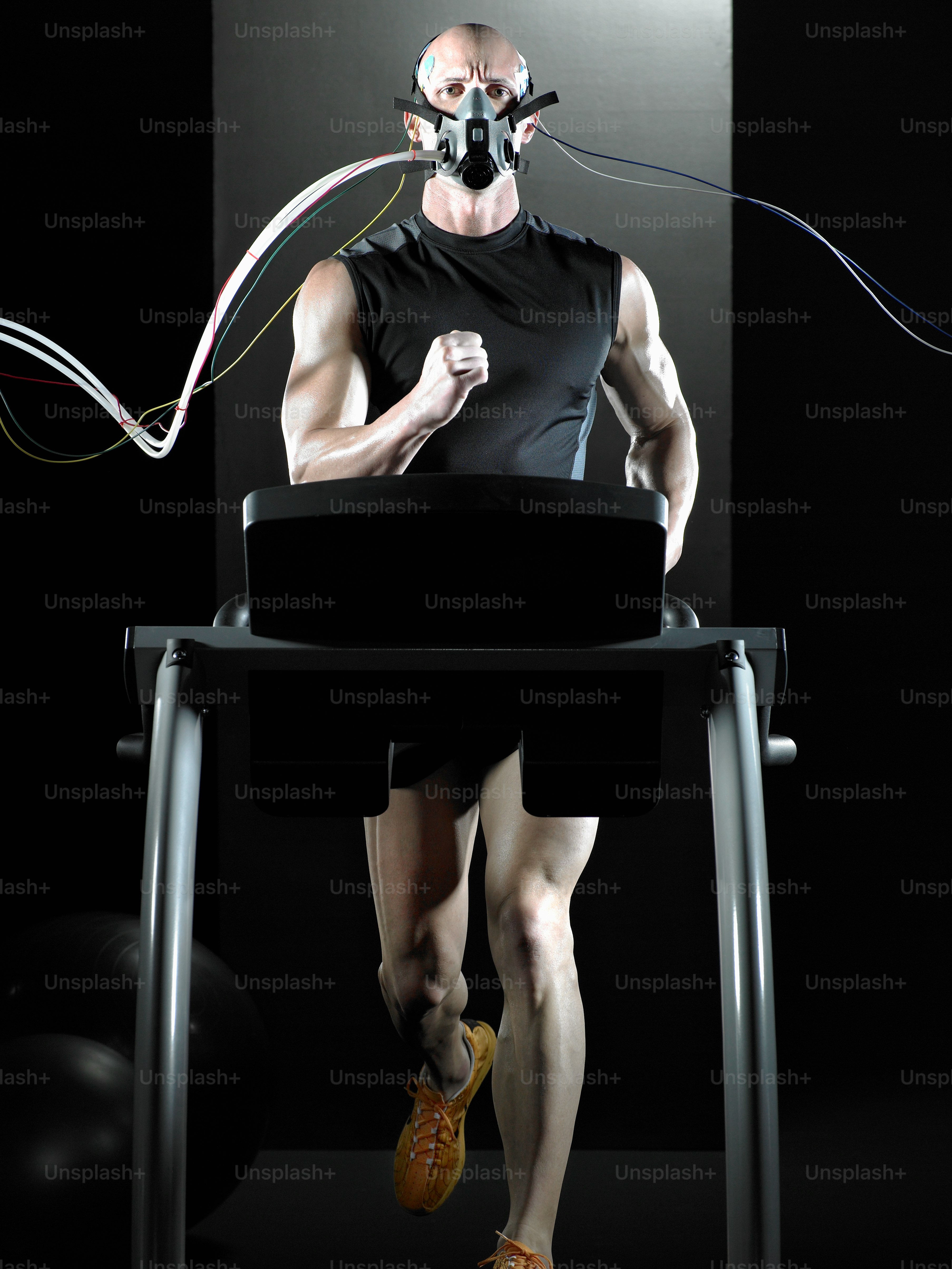 A man running on a treadmill with a mask on photo – Gym Image on Unsplash