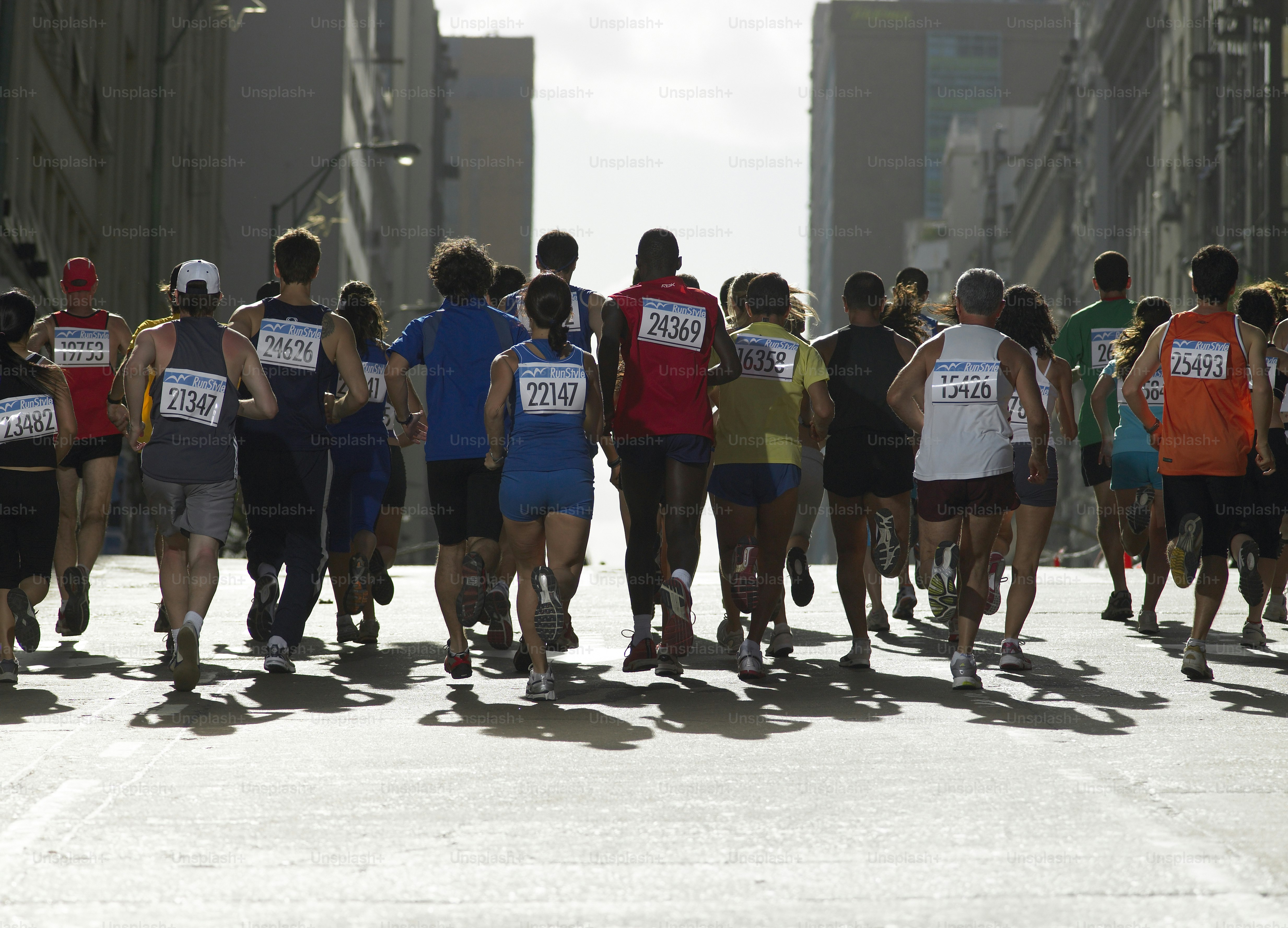 A group of people running in a marathon photo – Running group Image on ...