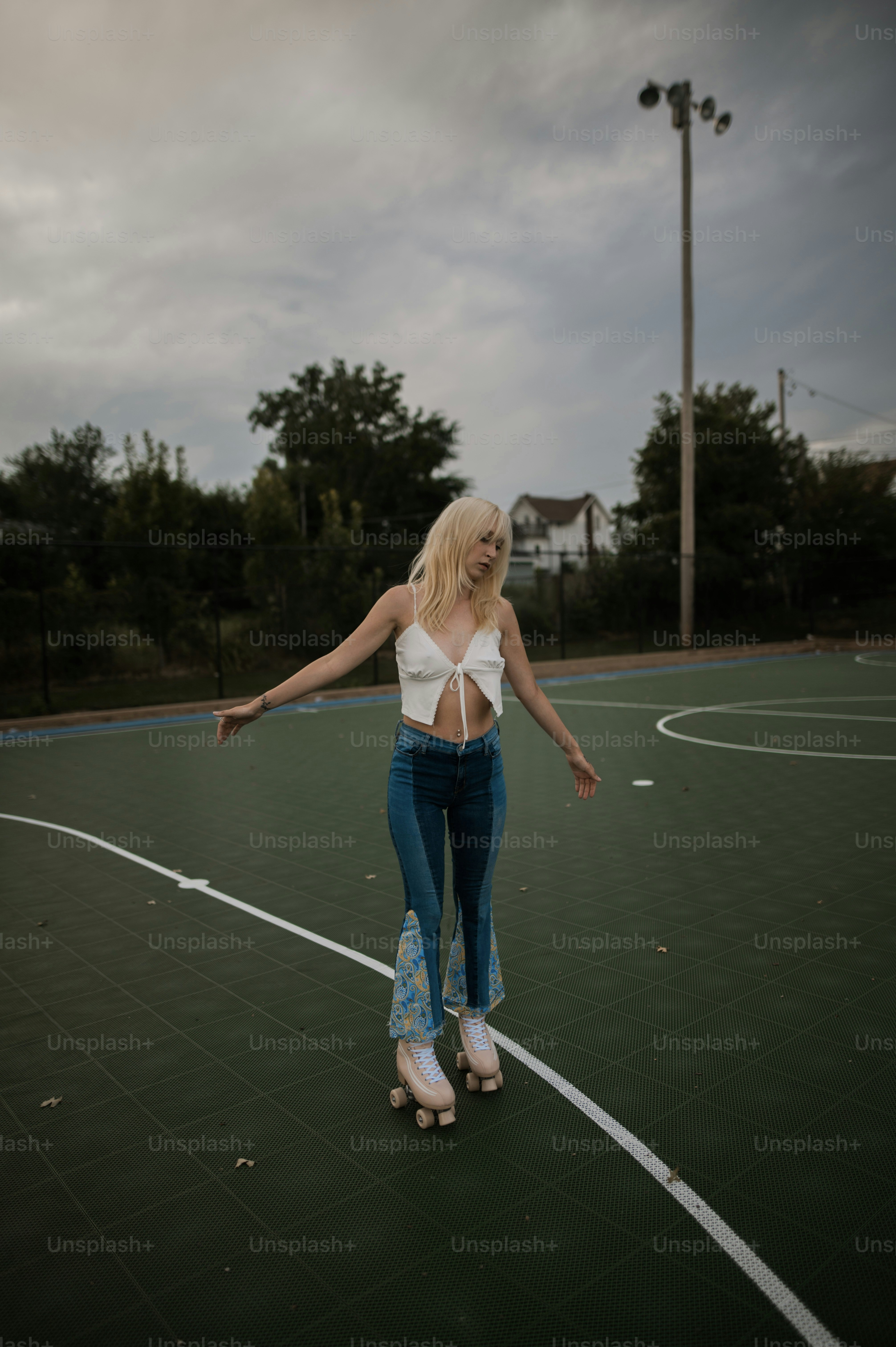 A woman standing on a basketball court with her hands on her hips photo ...