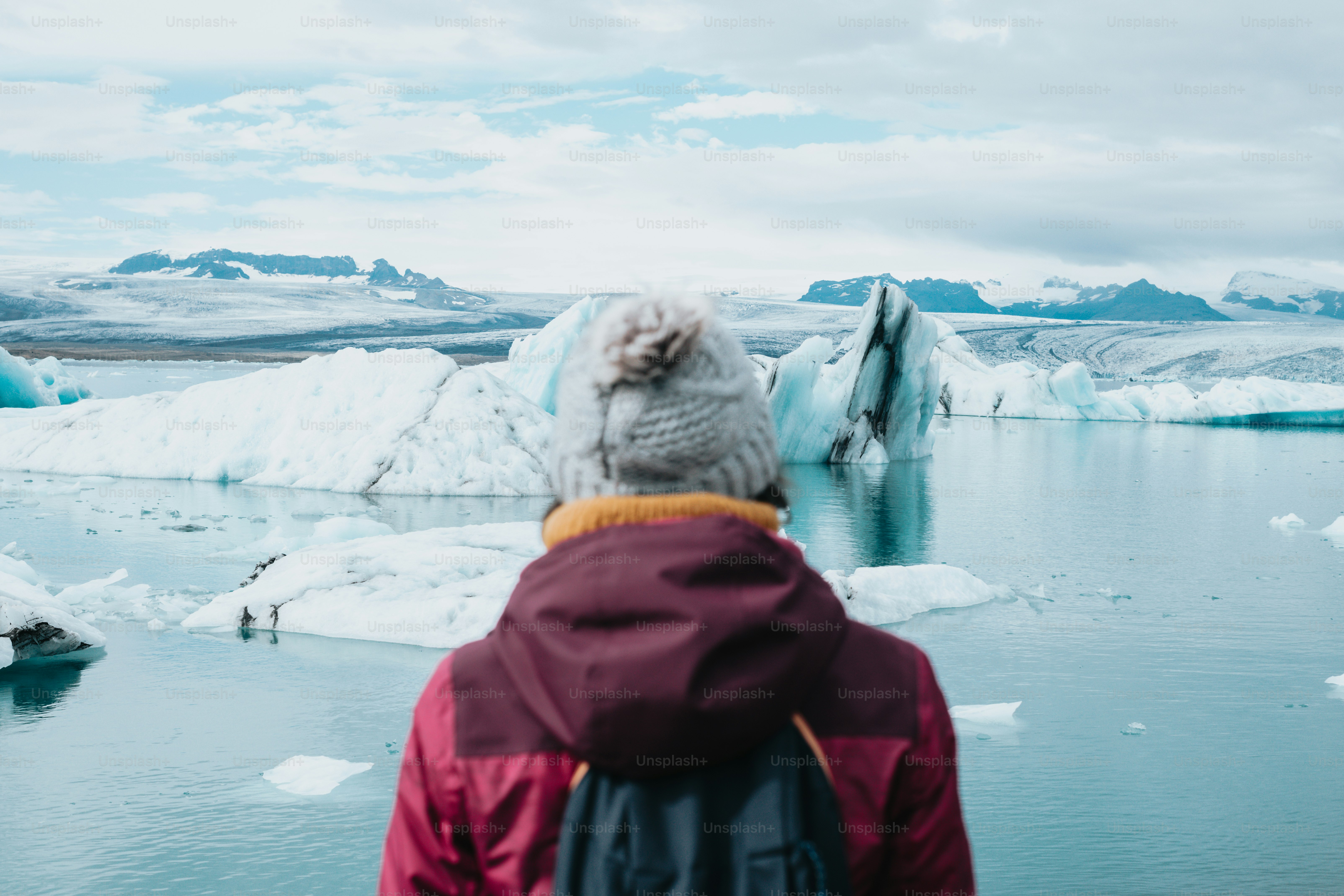 A person standing in front of a body of water photo – Outdoors Image on ...