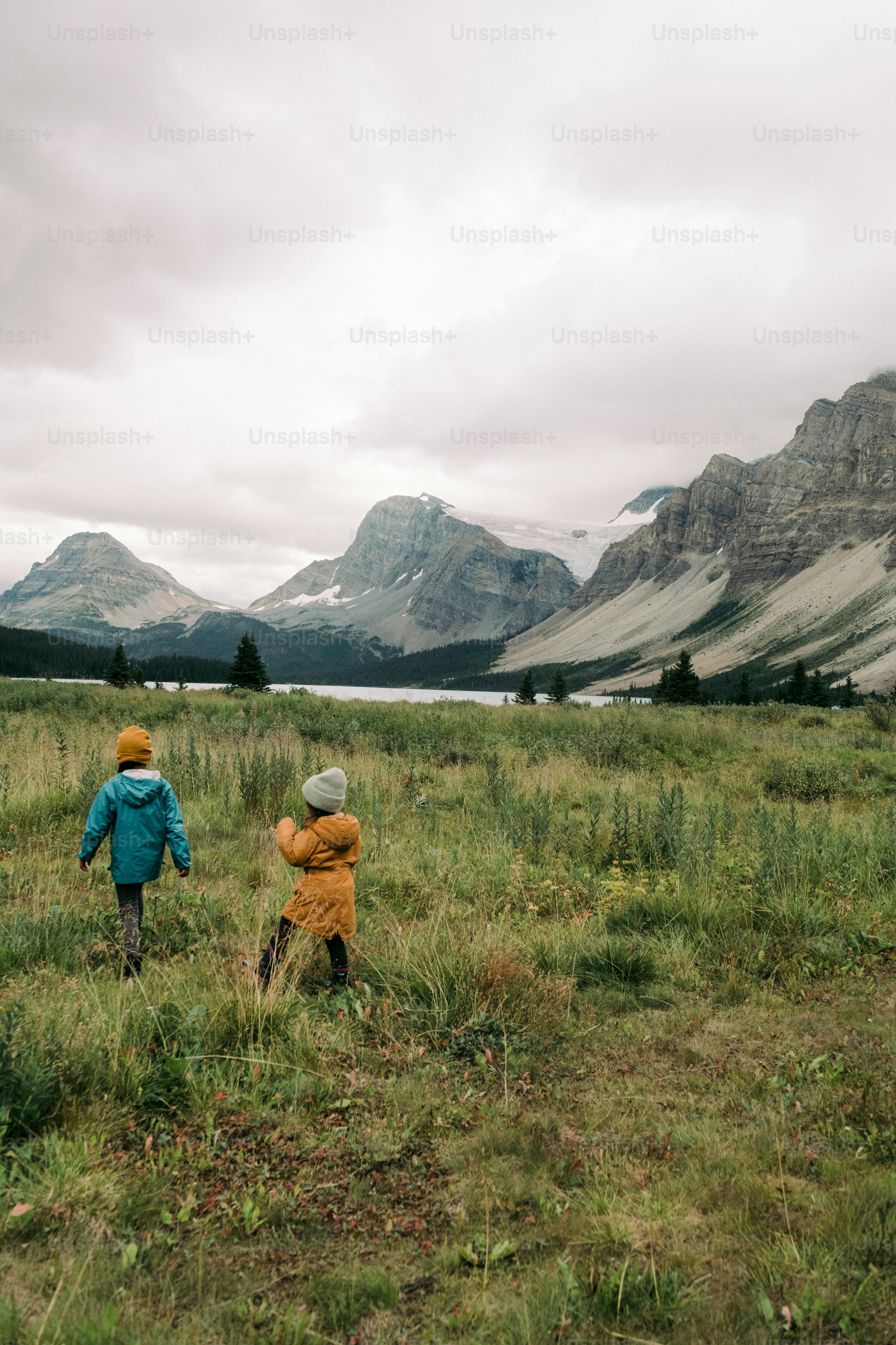 A couple of kids that are standing in the grass photo – Outdoors Image ...