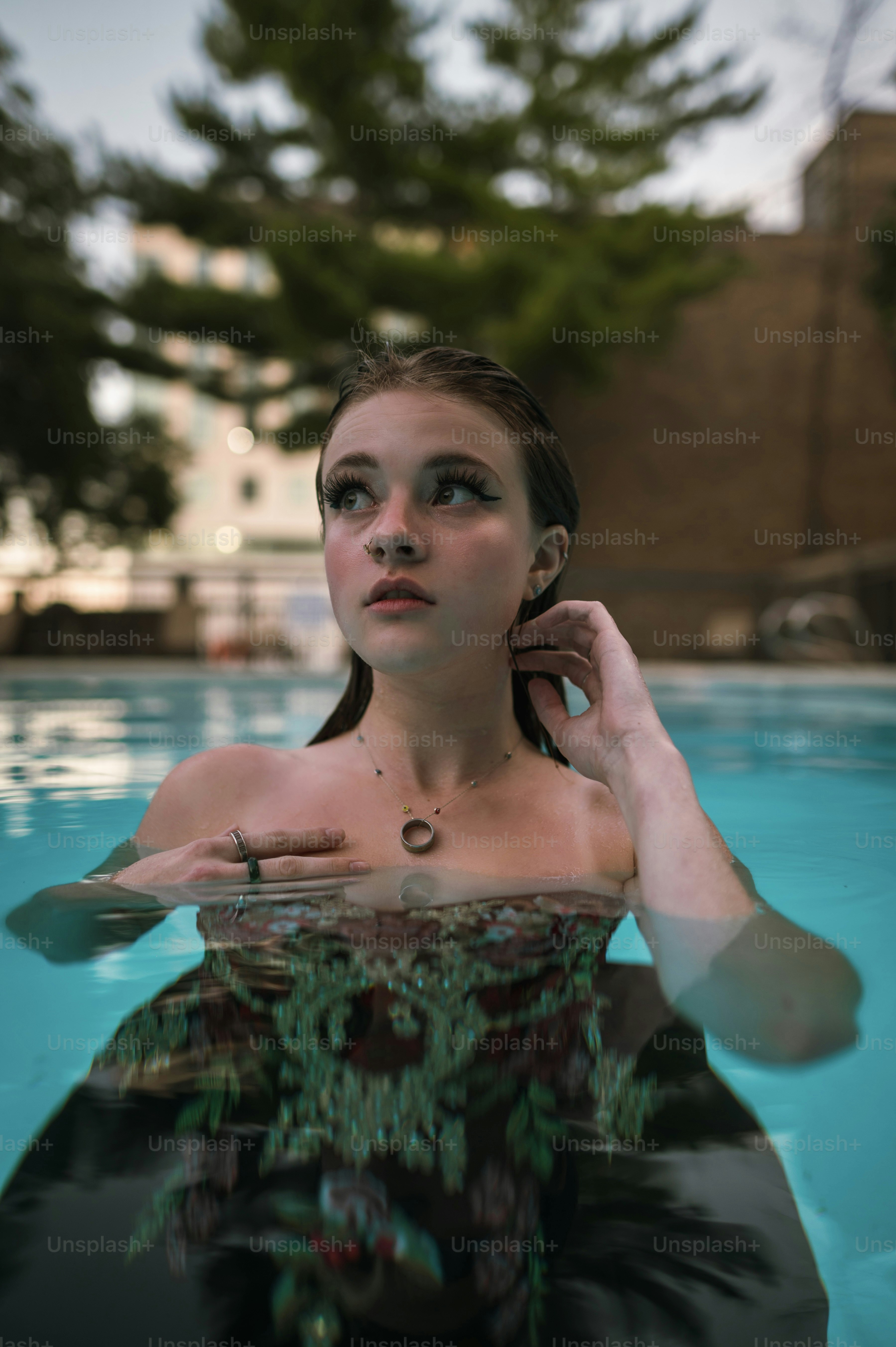 A woman in a black dress standing in a pool photo – Photoshoot Image on ...