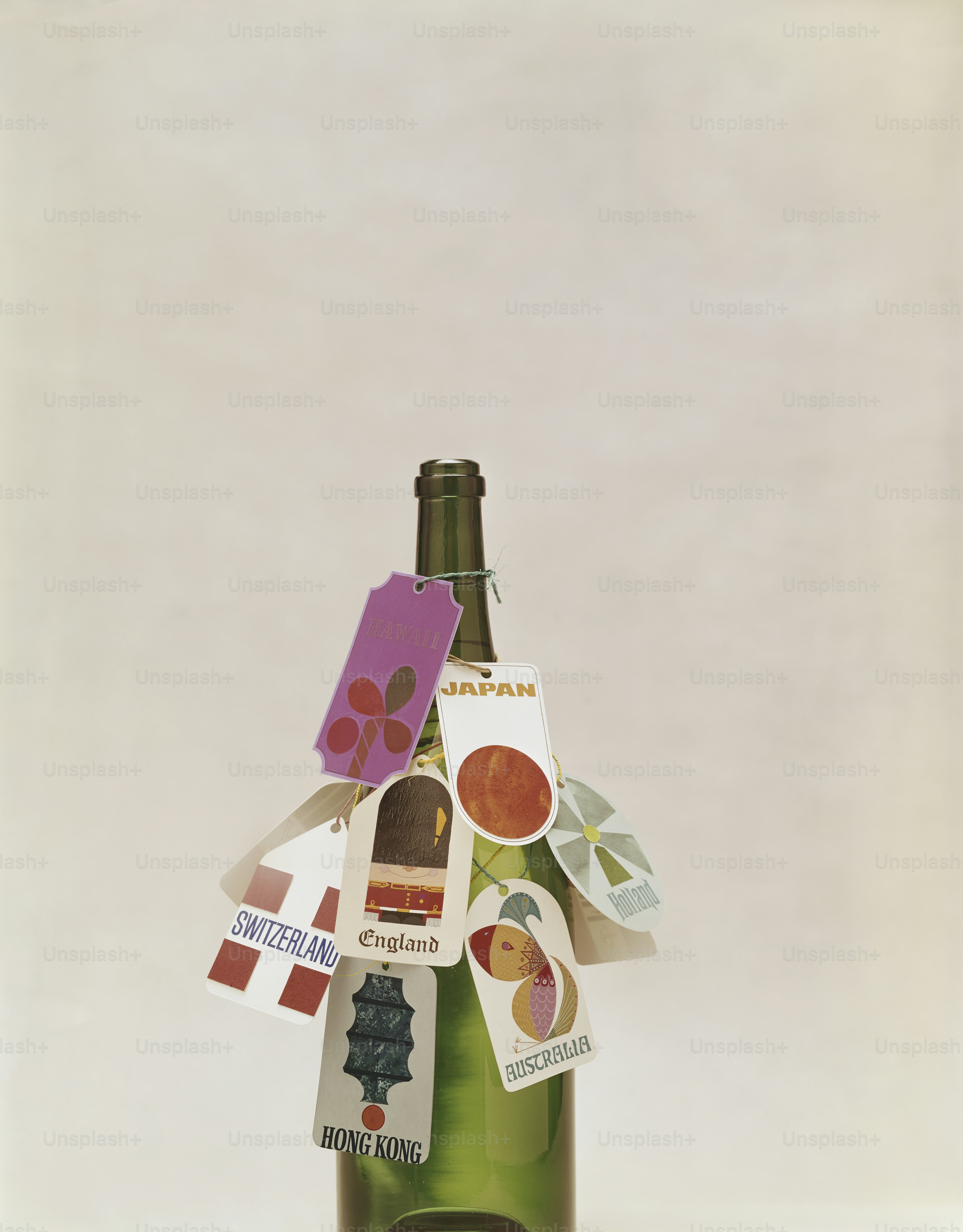 A bottle of wine with a bunch of stickers on it photo – Etiquette Image ...