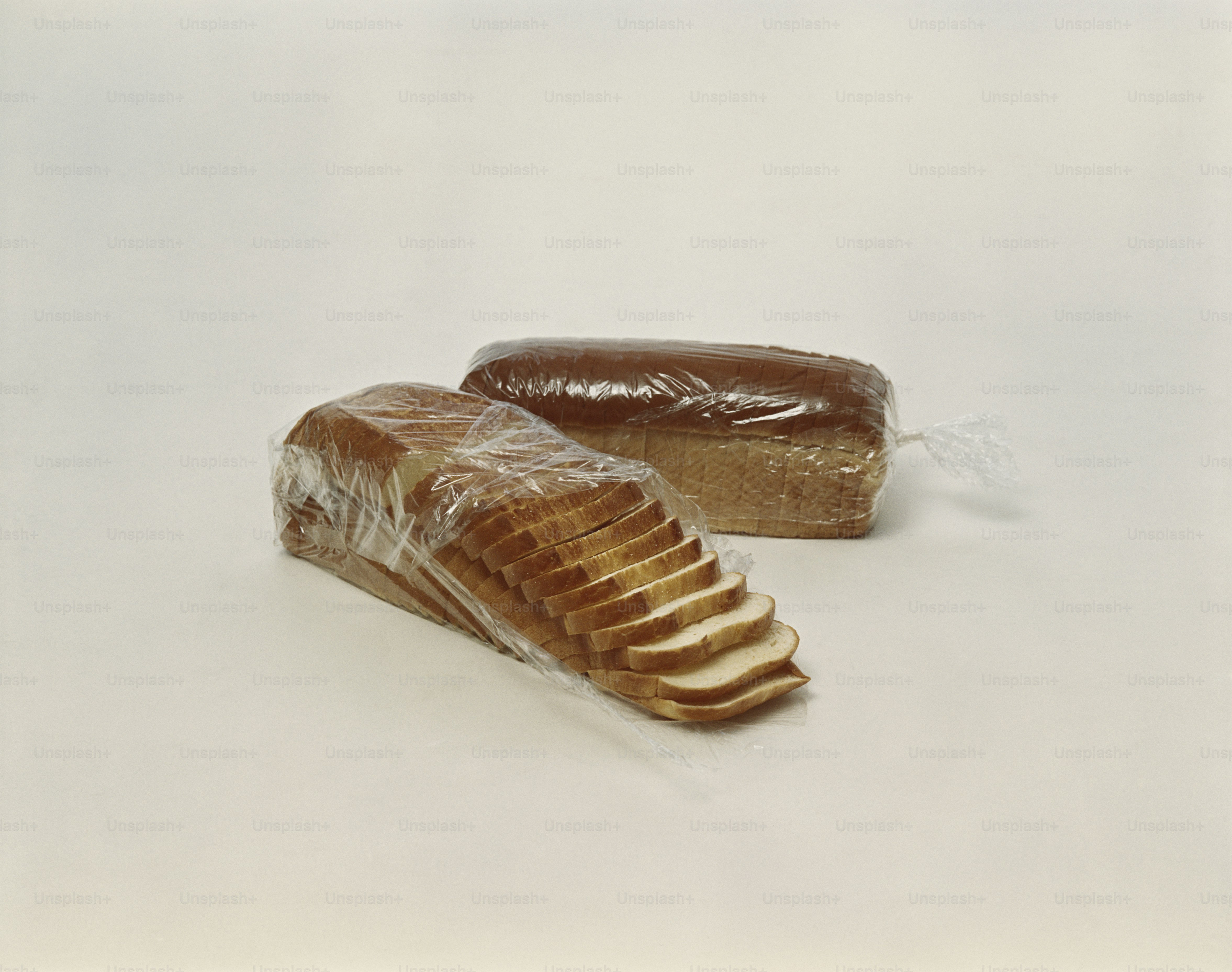 A loaf of bread and a piece of bread wrapped in plastic photo – Random ...