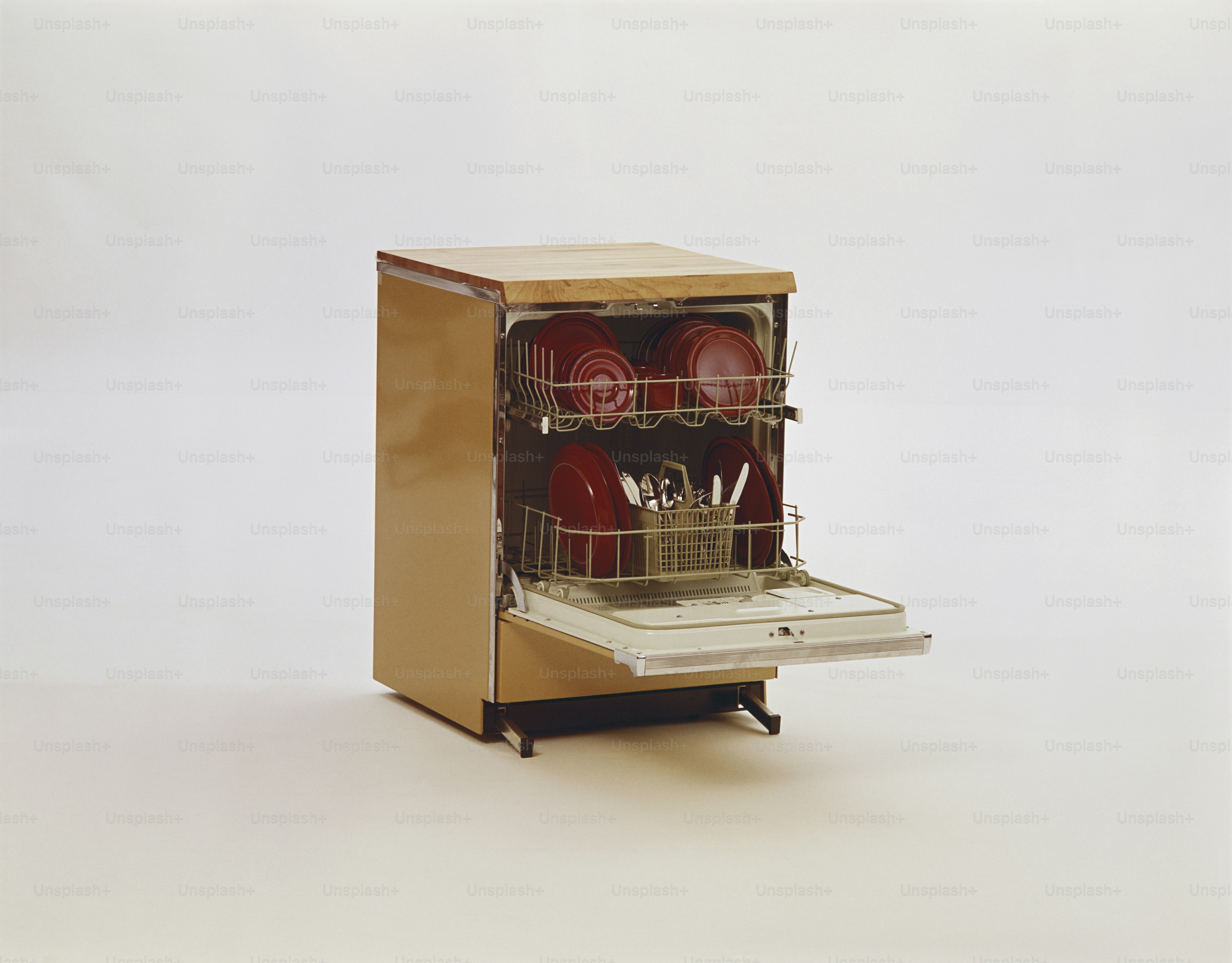 An open dishwasher with red dishes in it photo – Red Image on Unsplash