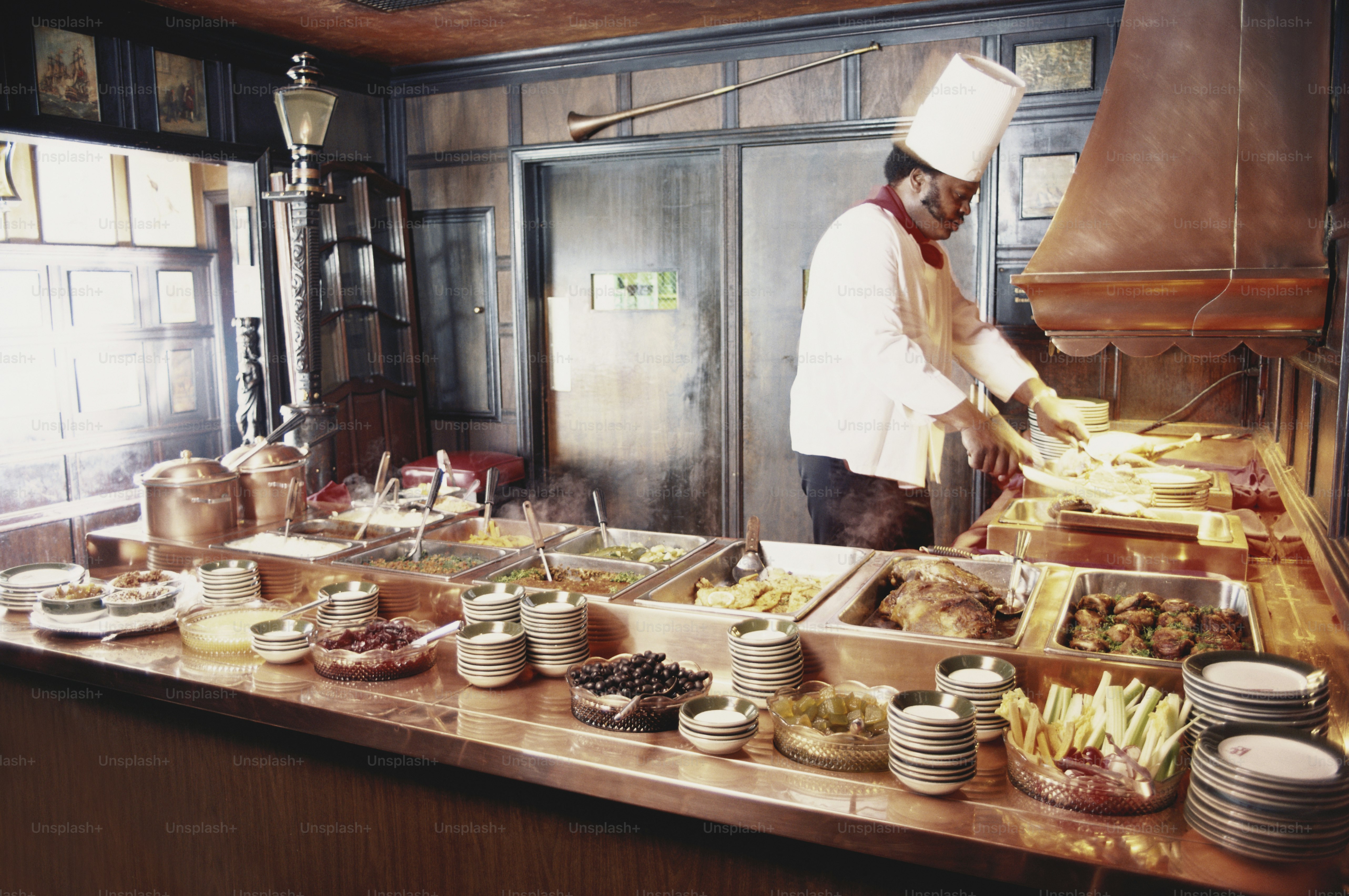 A chef preparing food in a restaurant kitchen photo – One person Image ...