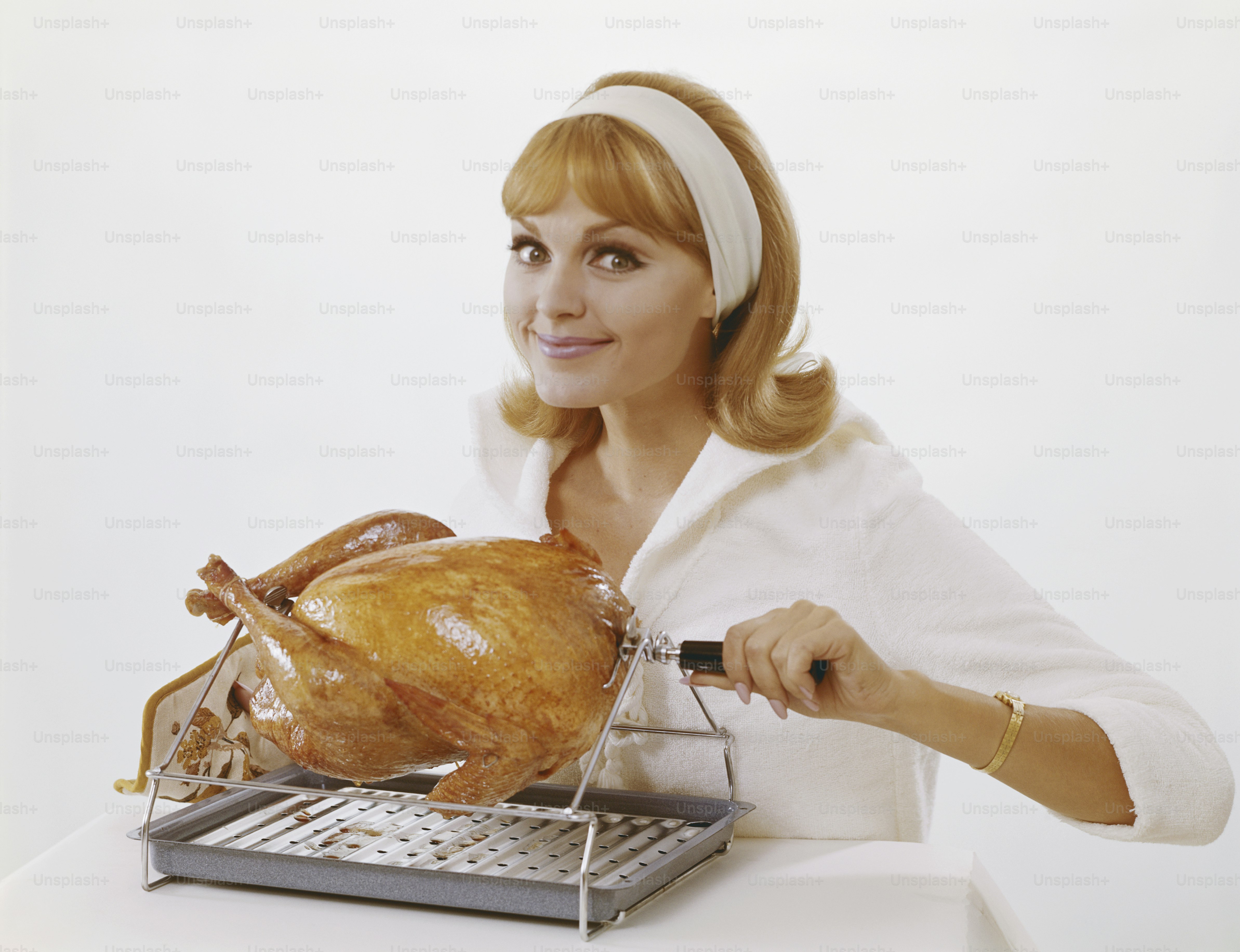 A woman holding a turkey in front of a keyboard photo – One person ...