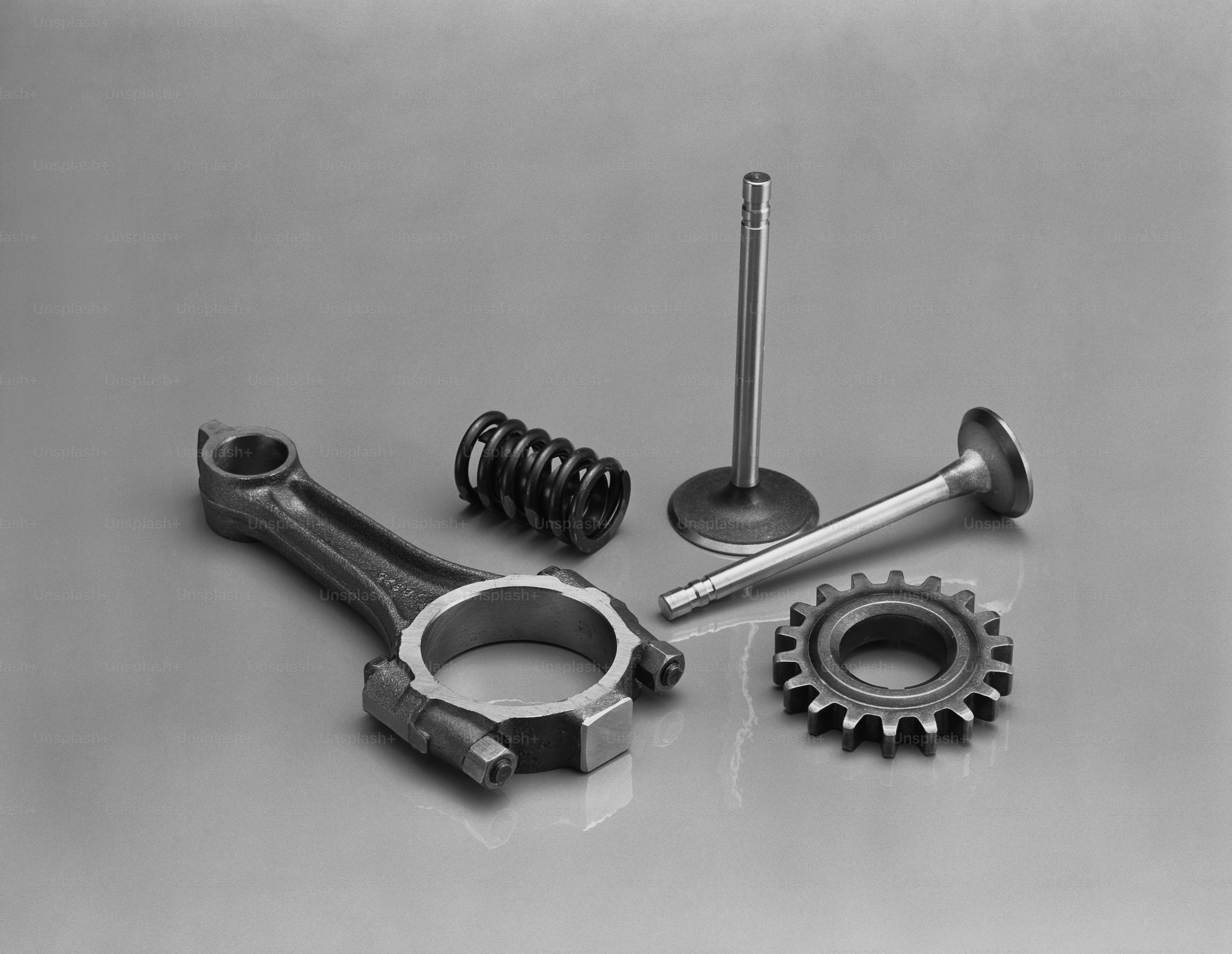 A group of metal parts sitting on top of a table photo – Cog Image on ...