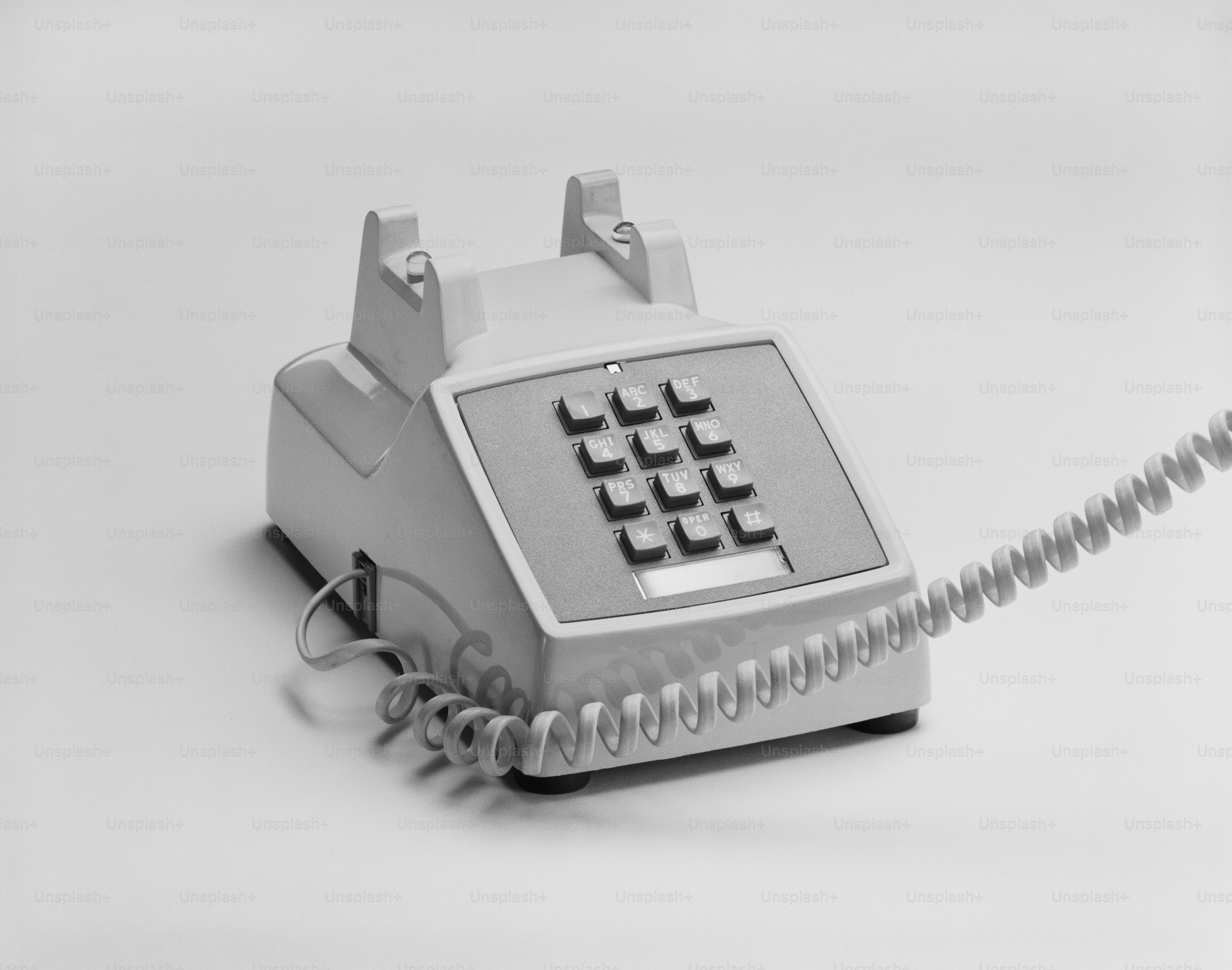 An old phone with a cord attached to it photo – Old telephone Image on ...