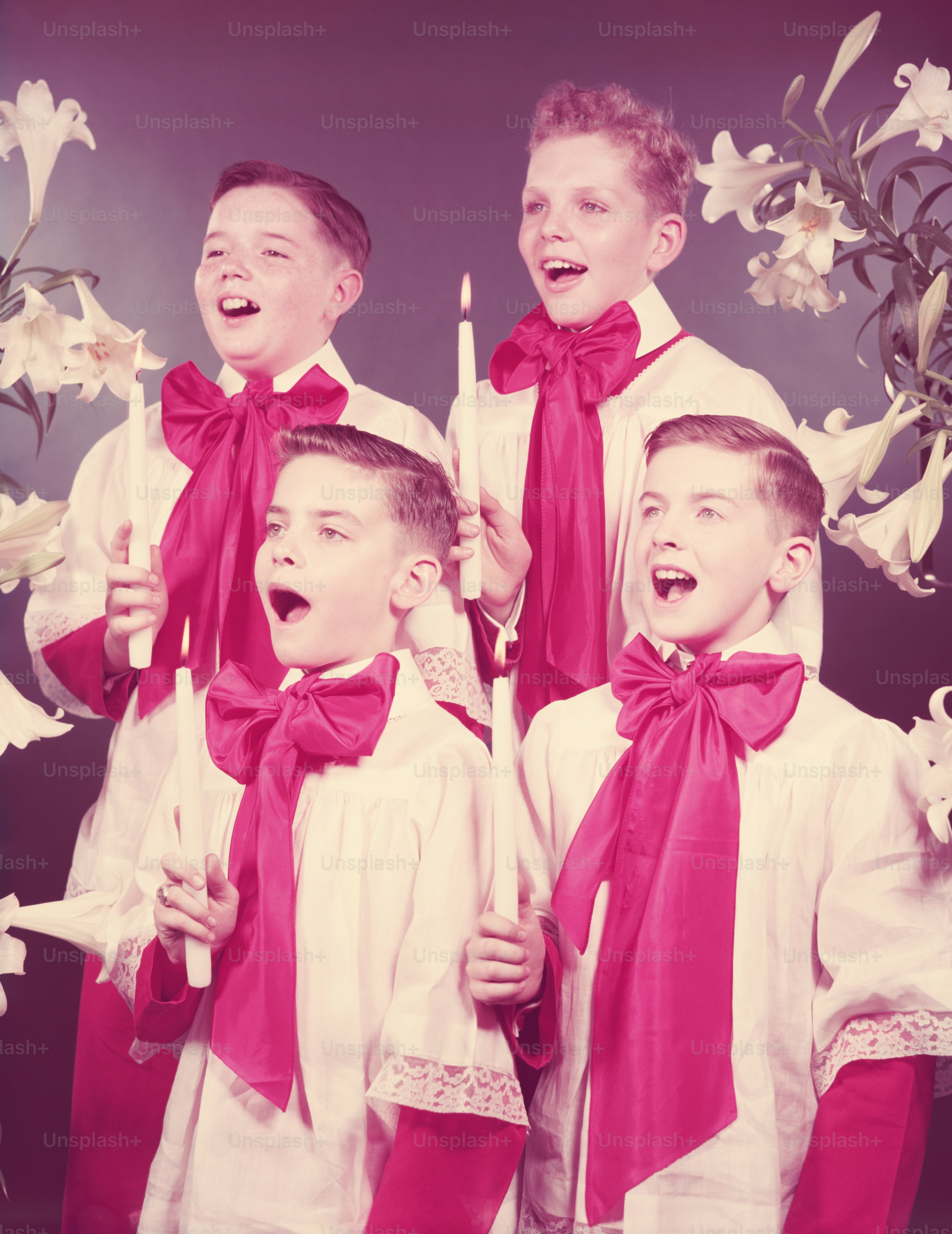 UNITED STATES - CIRCA 1950s: Four boys in choir robes, singing, holding ...