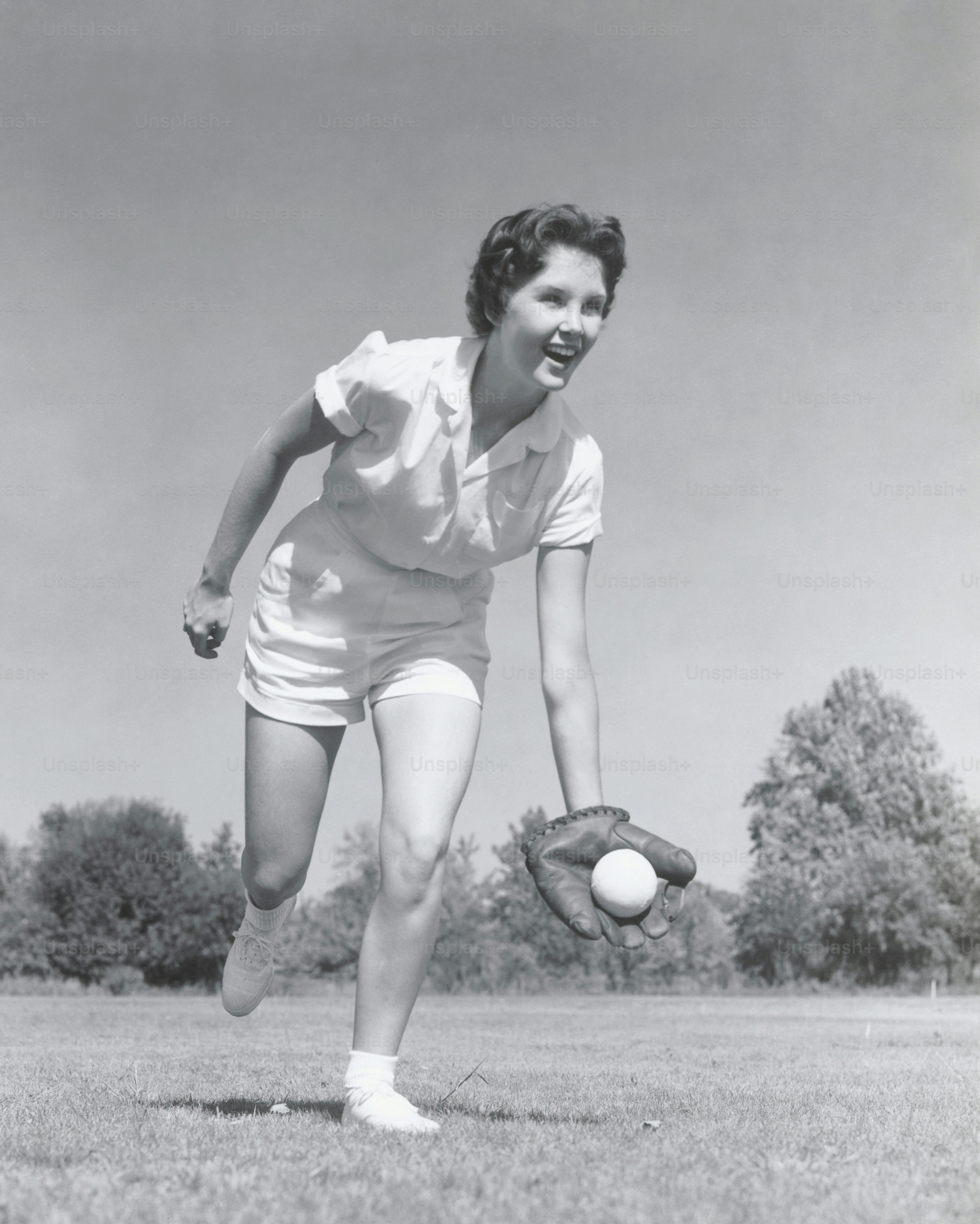 UNITED STATES - CIRCA 1950s: Young woman catching baseball in glove ...