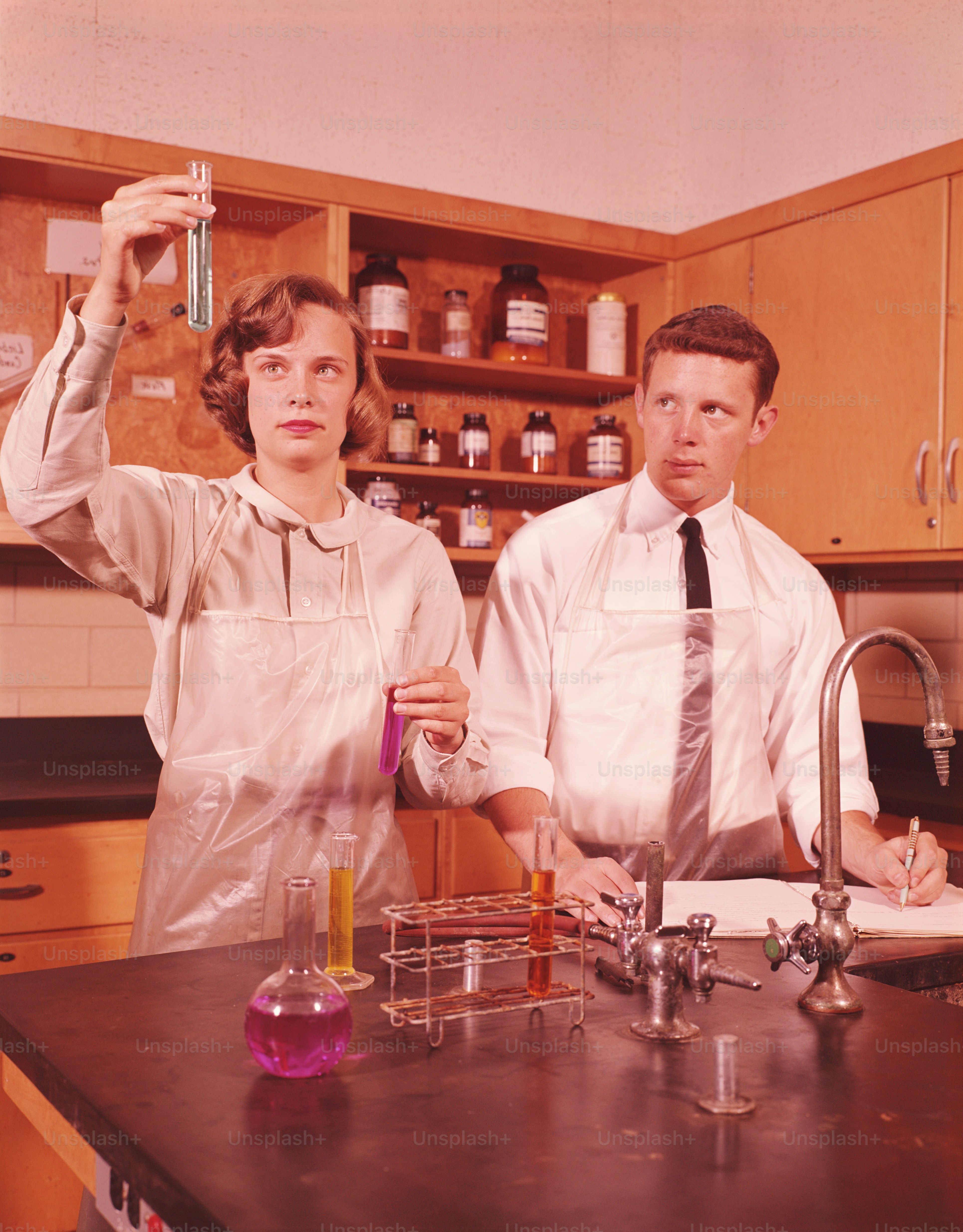 UNITED STATES - CIRCA 1960s: Two students in chemistry laboratory, girl ...