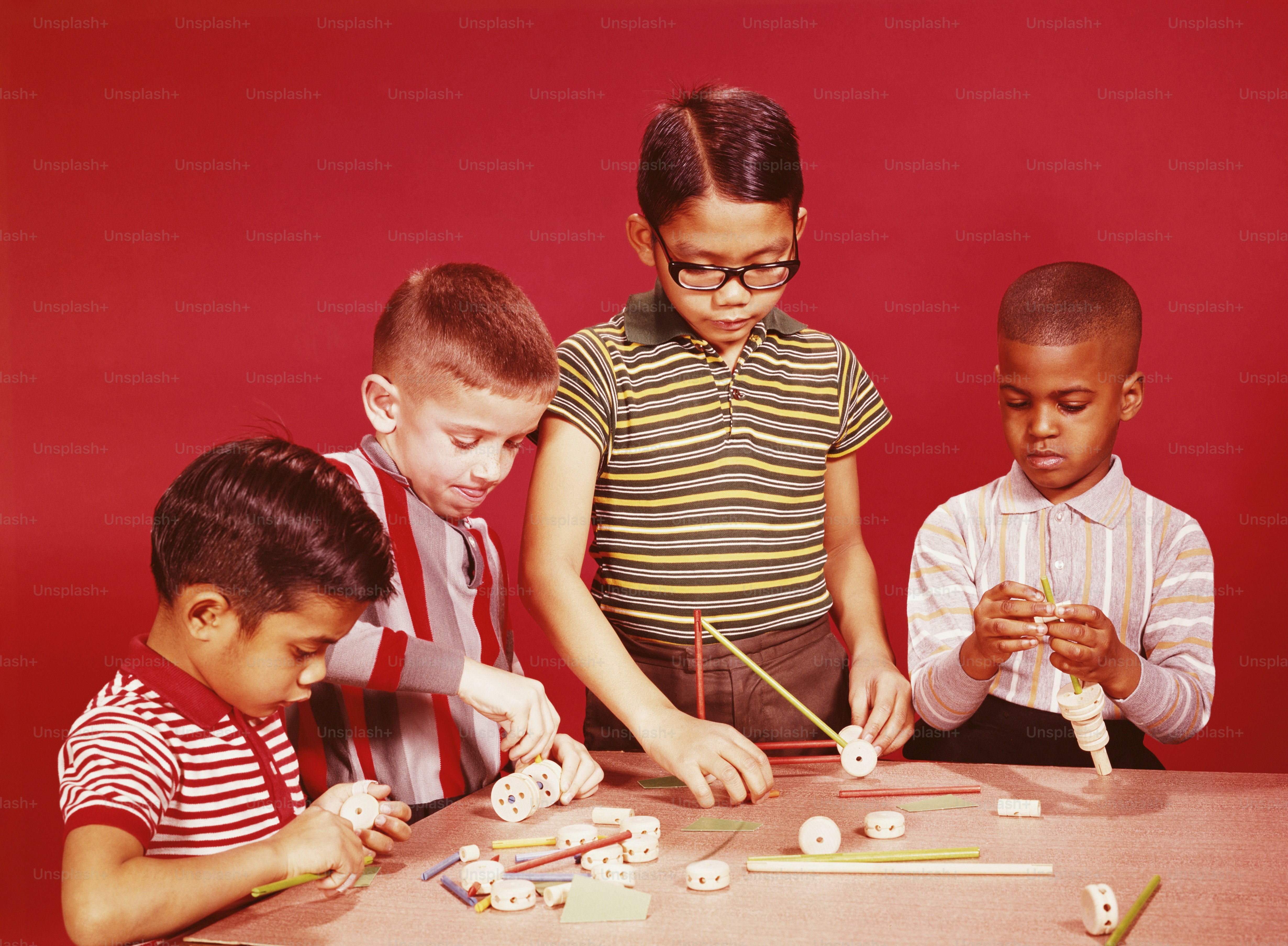 UNITED STATES - CIRCA 1960s: Four boys playing with tinker toy building ...