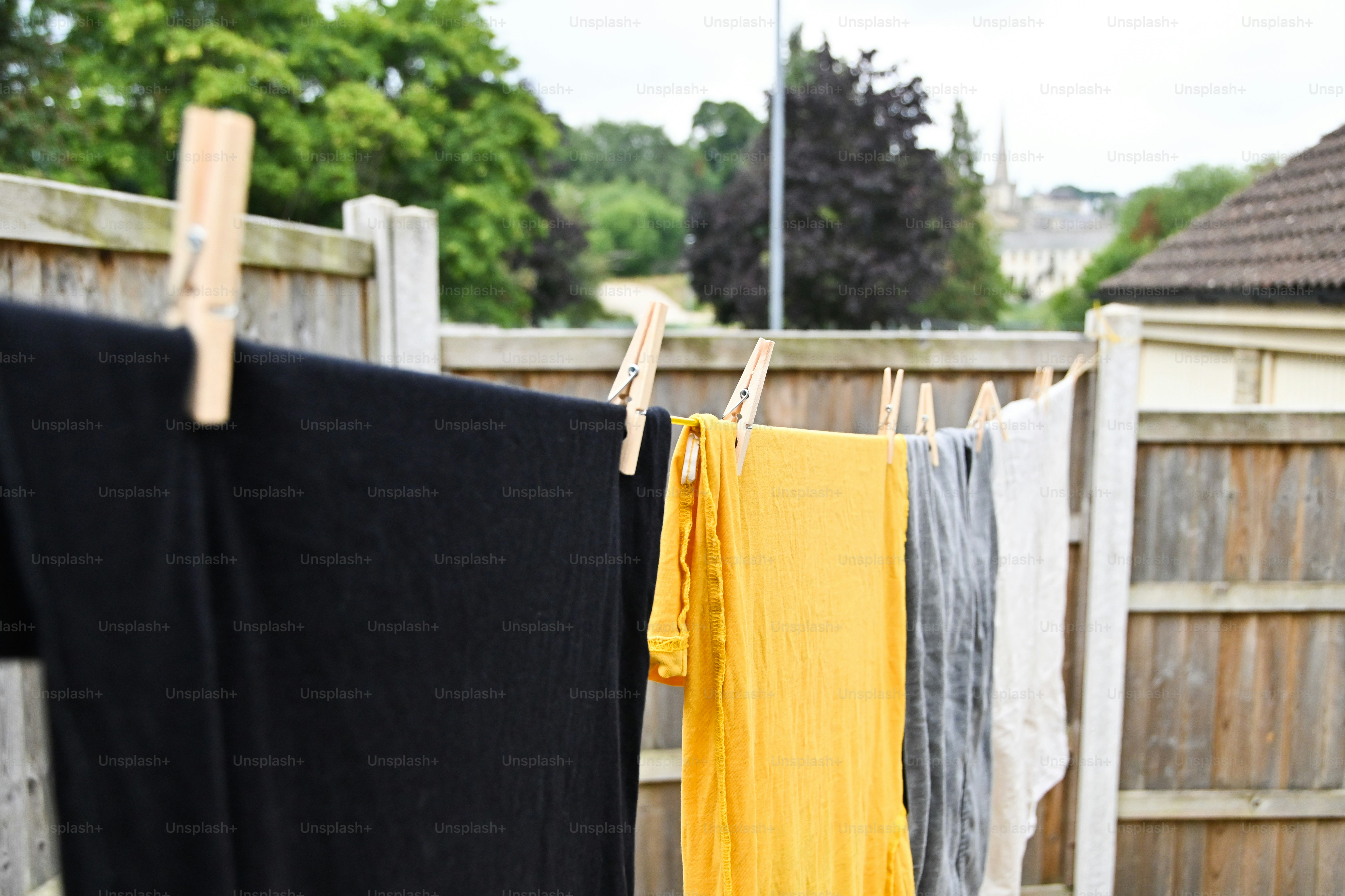 A line of clothes hanging on a clothes line photo – Clothes rack Image ...