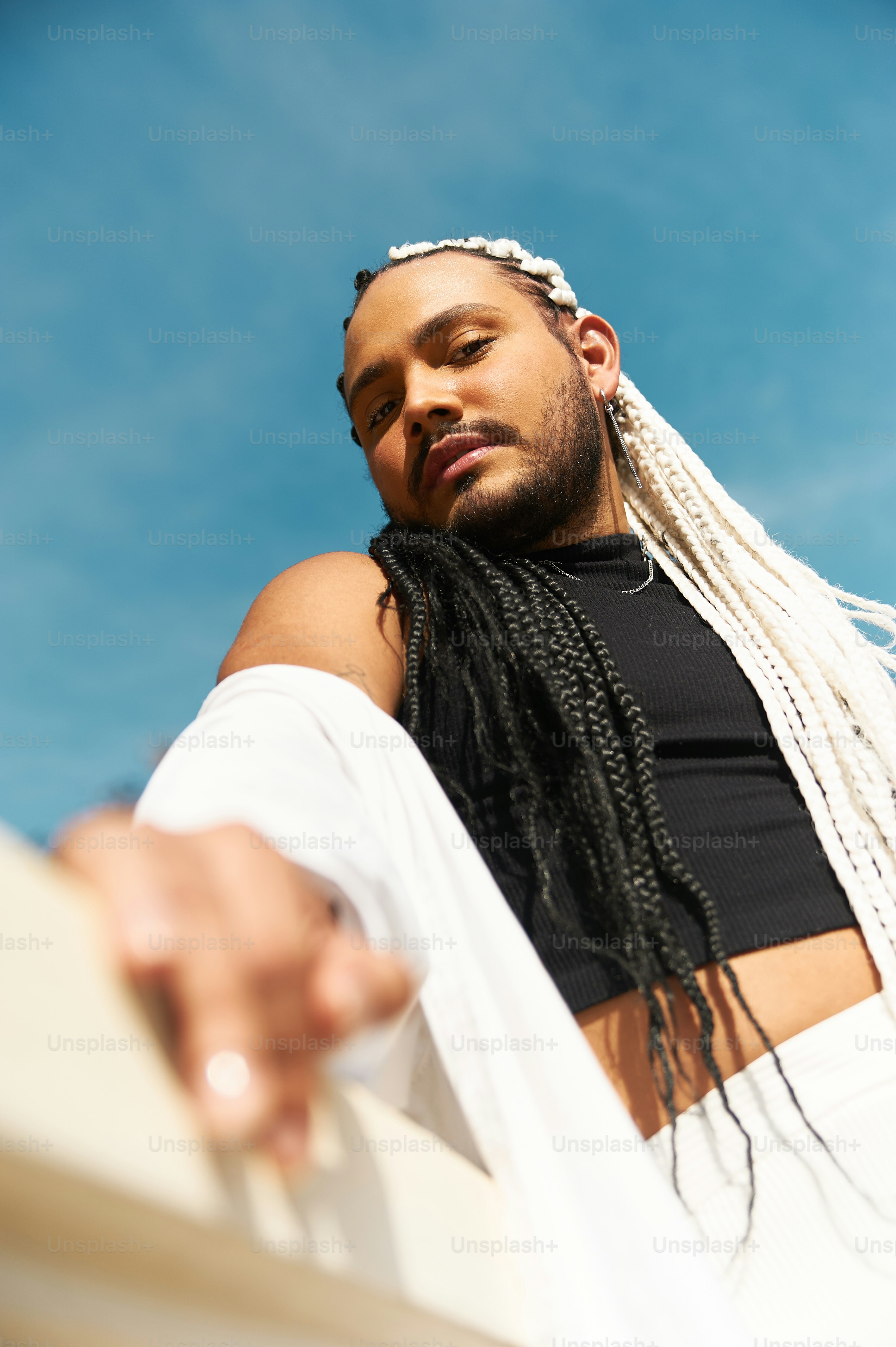 A man making a peace sign with his fingers photo – Looking down Image ...