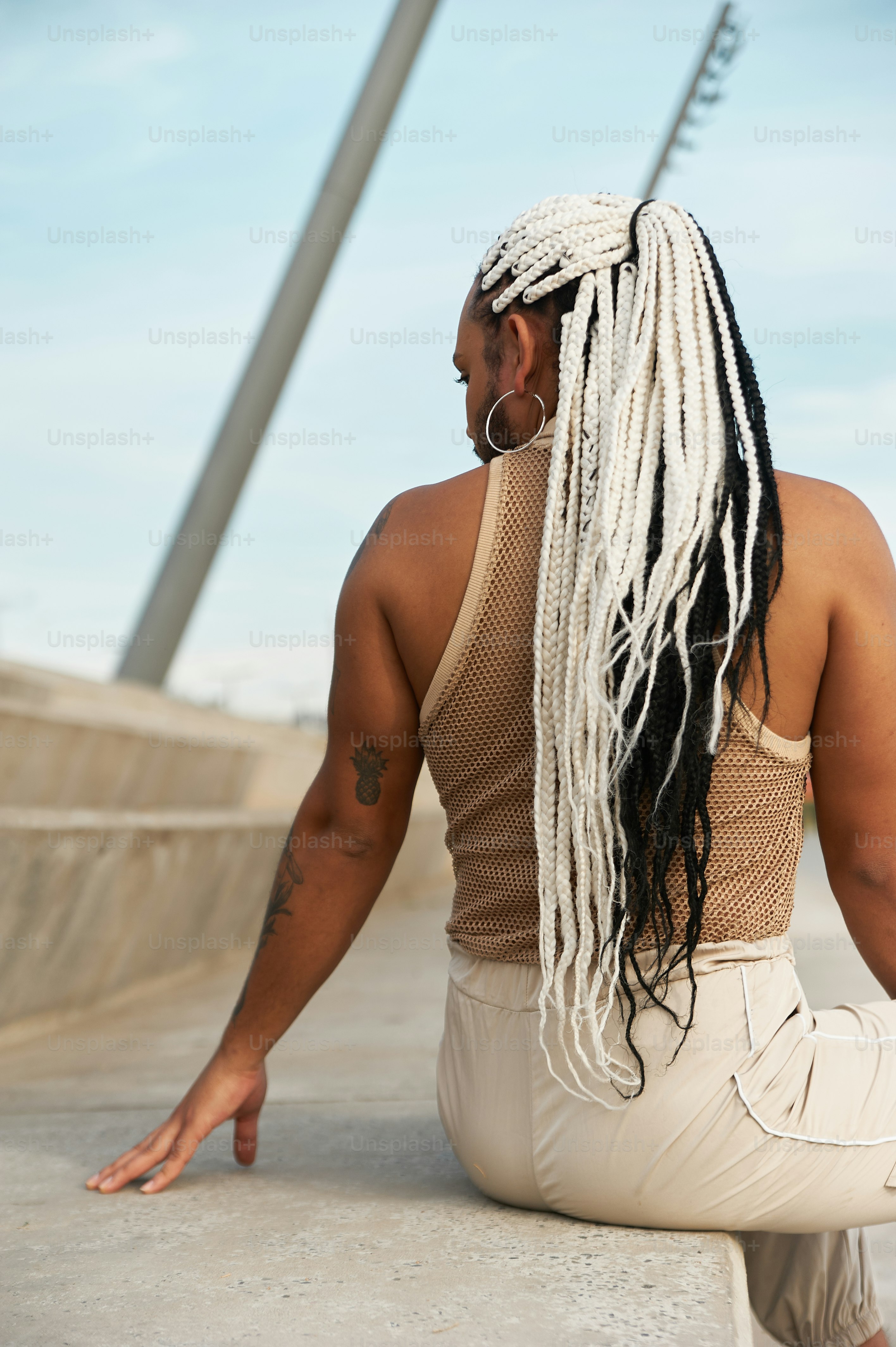 A man with dreadlocks sitting on the ground photo – Dreadlocks Image on ...